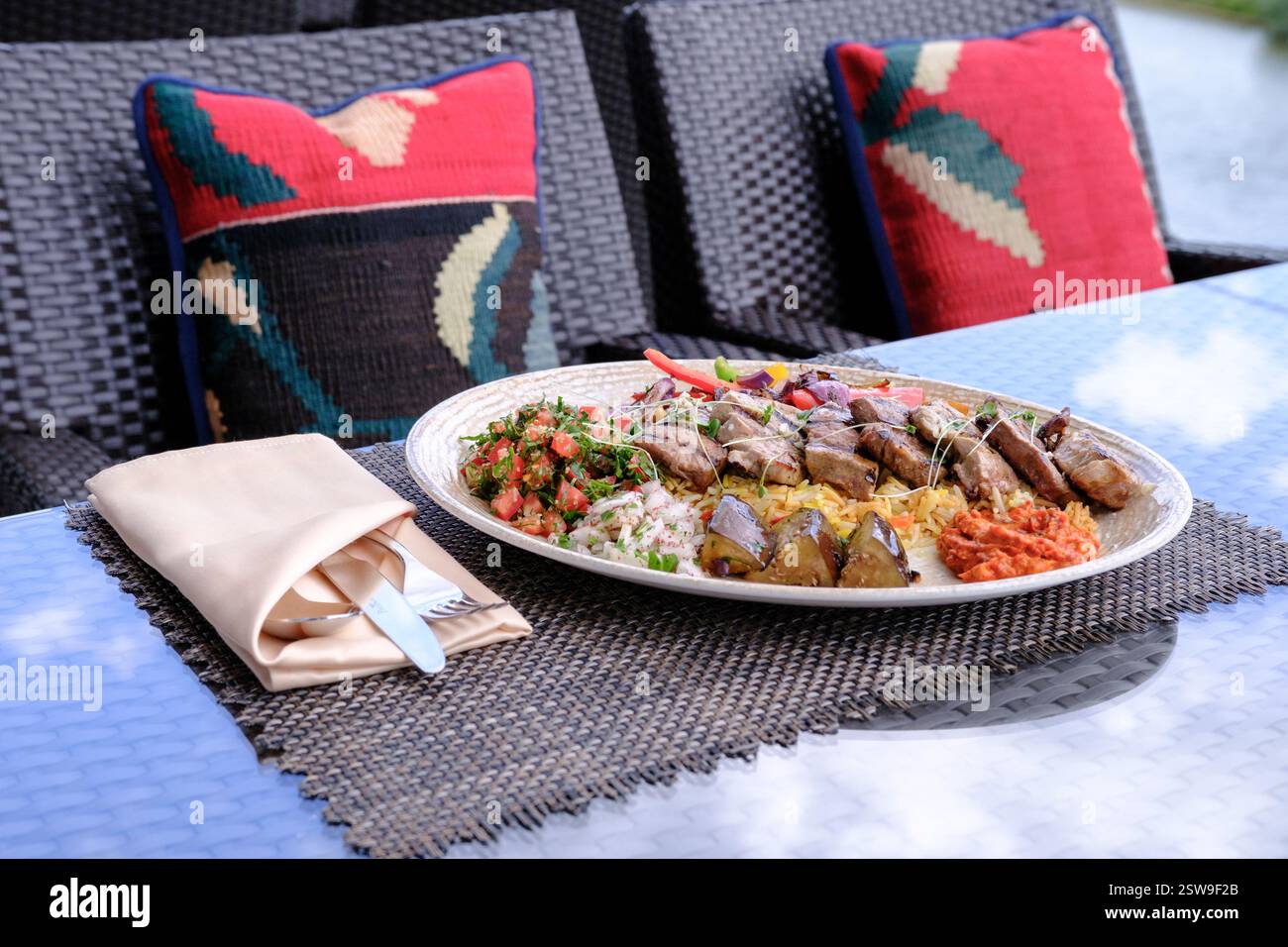 Grilled meat platter with rice vegetables and various side dishes ...