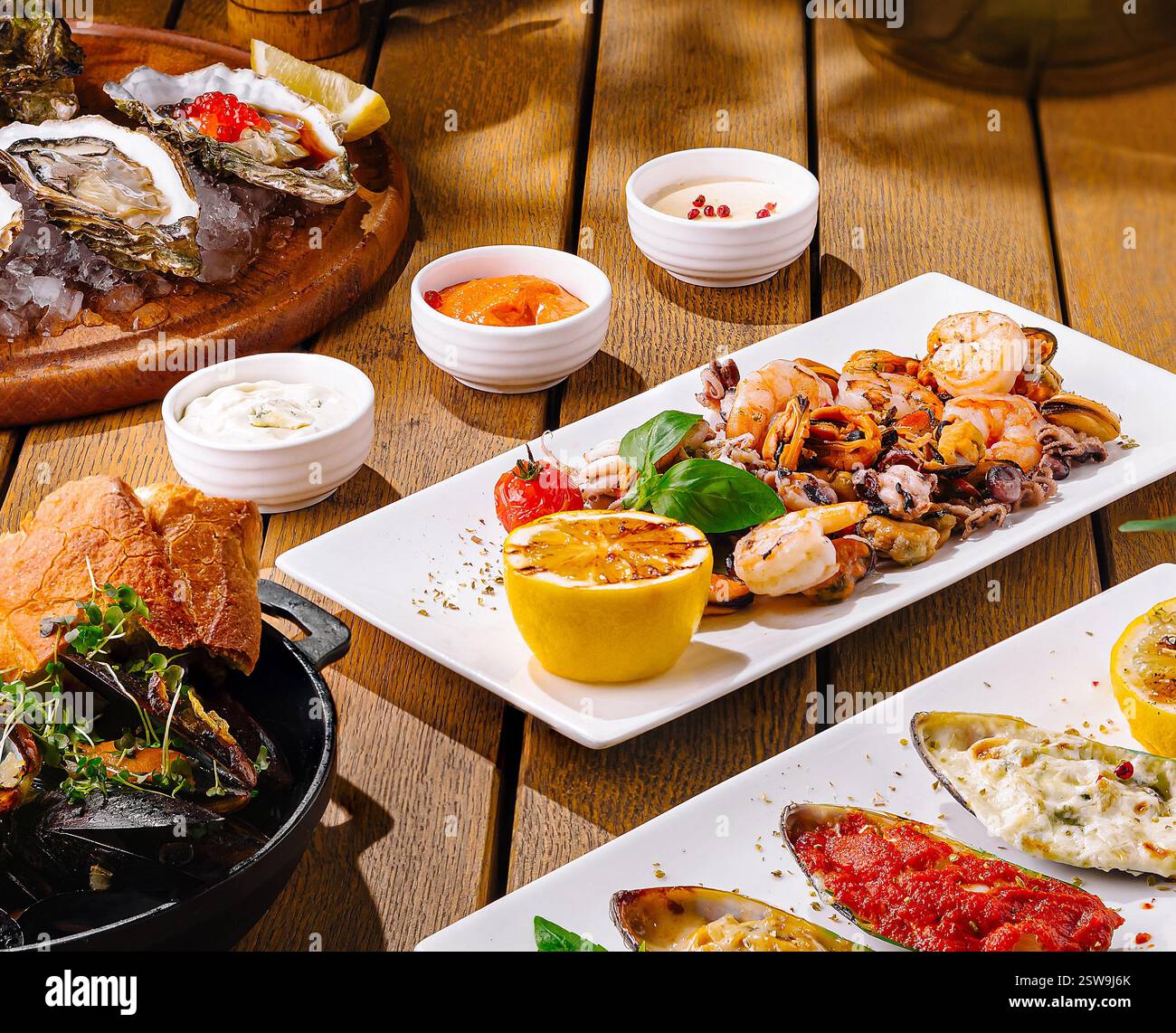 Gourmet mediterranean feast on rustic wooden table Stock Photo - Alamy
