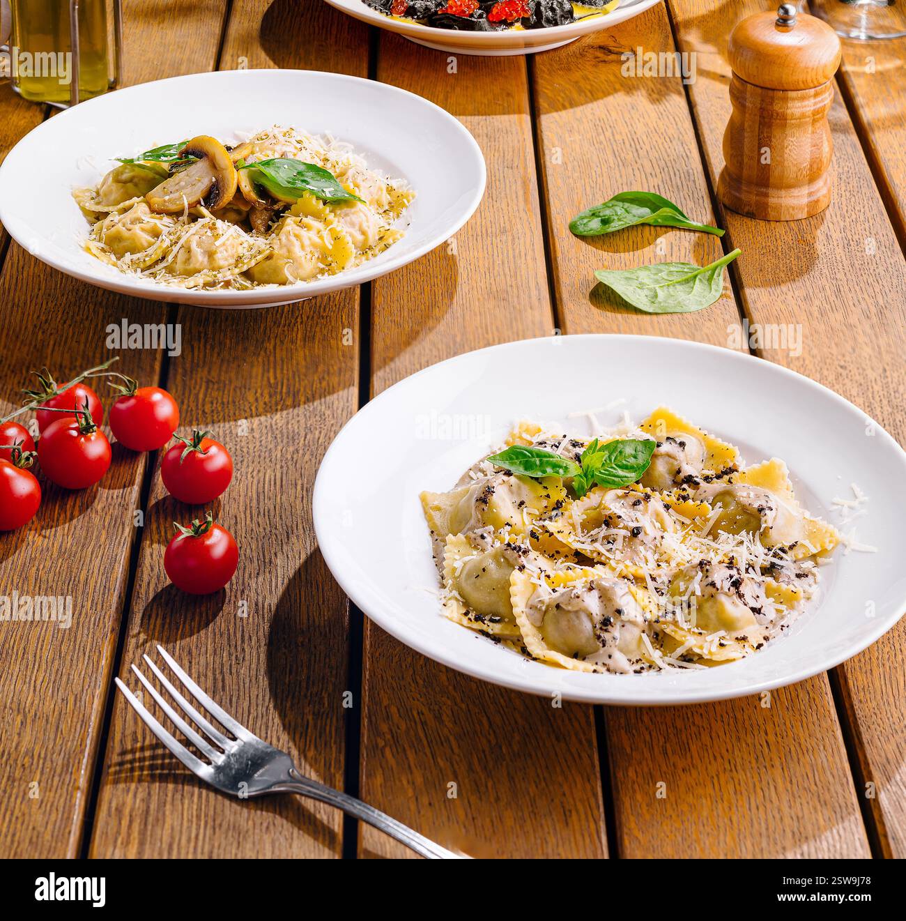 Three types of pasta served elegantly on white plates, ready for a fine ...