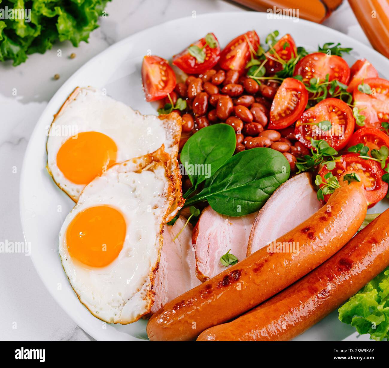 Freshly cooked delicious english breakfast with fried eggs and sausages ...