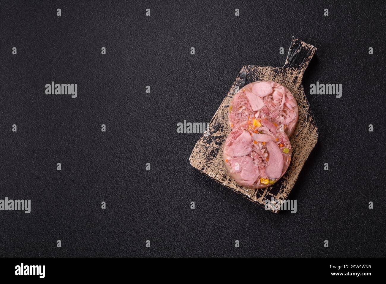 Homemade brawn with salt, spices, herbs and vegetables on a dark ...