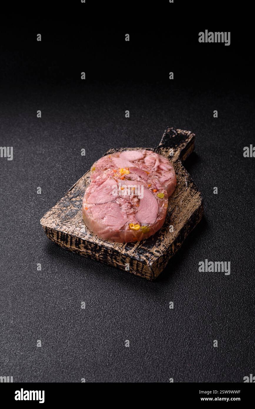 Homemade brawn with salt, spices, herbs and vegetables on a dark ...