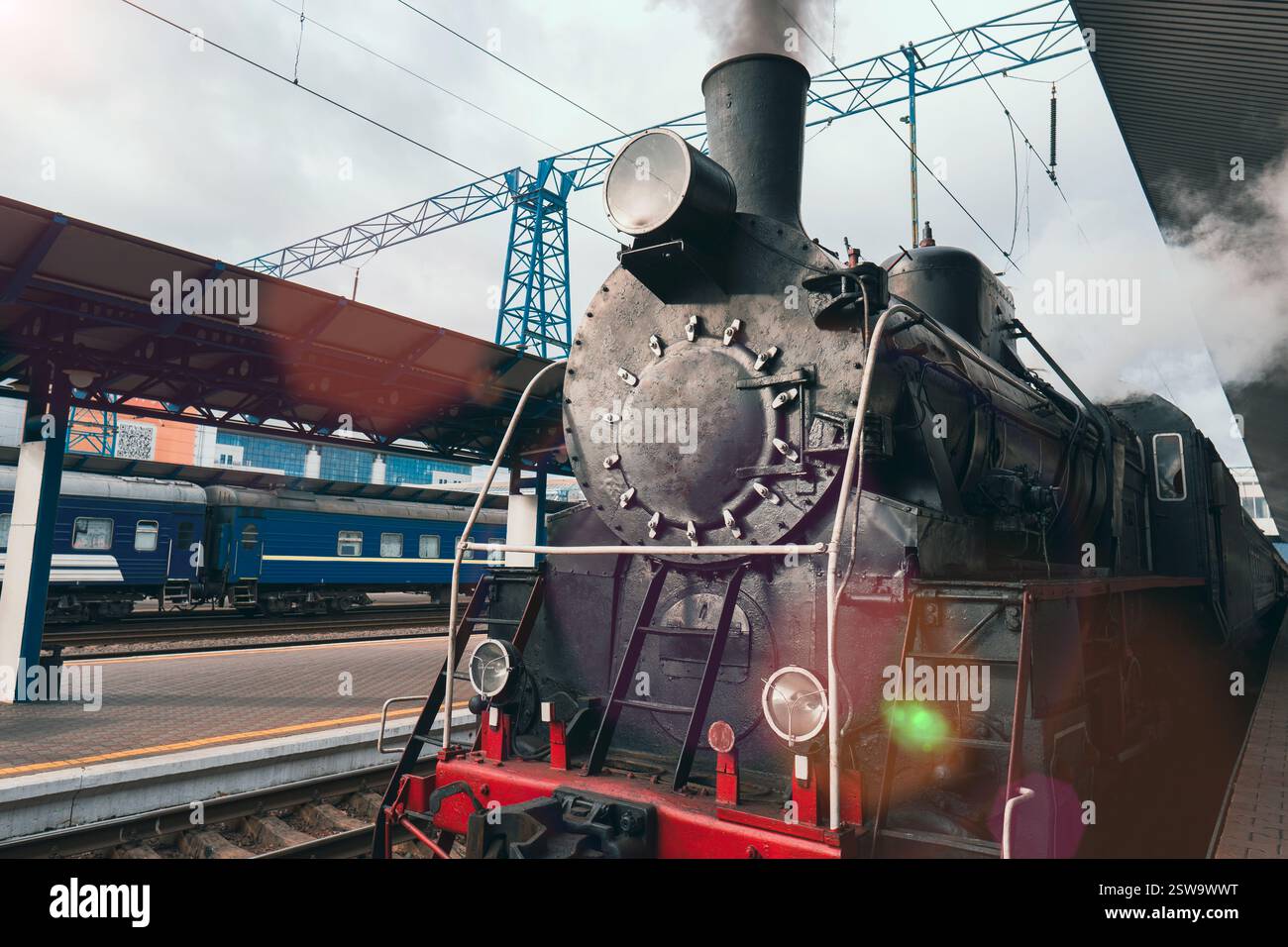 An old vintage steam locomotive is preparing to depart from the ...