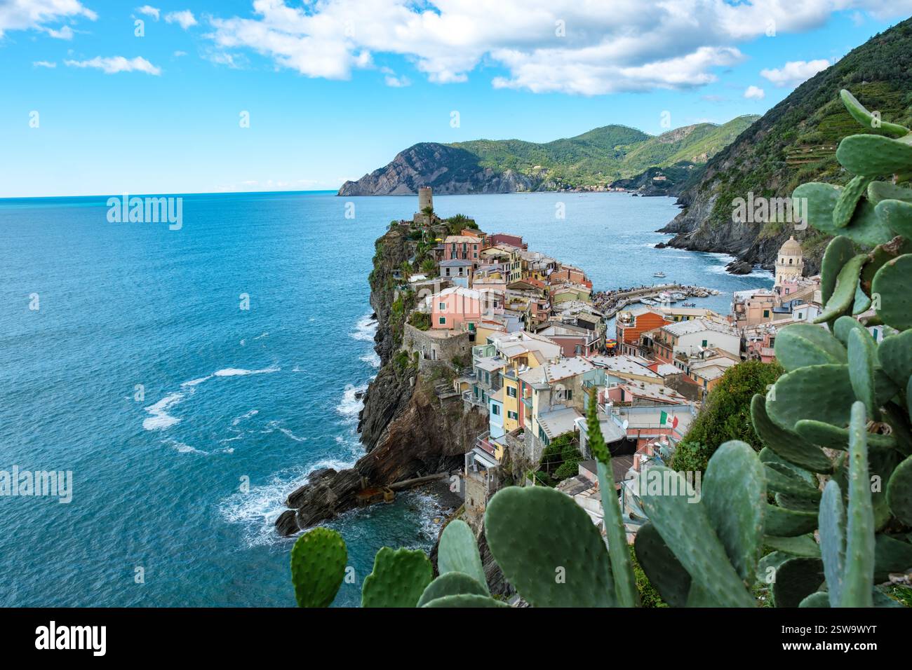Vernazza, a picturesque village in Cinque Terre, glimmers under a vibrant sky. The colorful ...