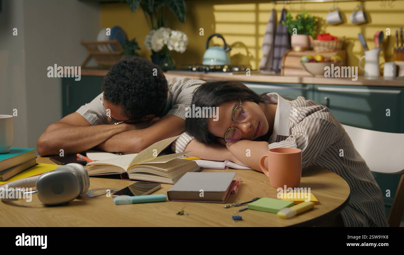 African American guy girl sleeping on kitchen table together studying ...