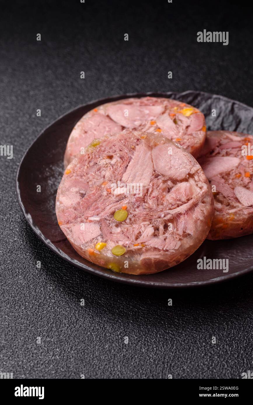 Homemade brawn with salt, spices, herbs and vegetables on a dark ...