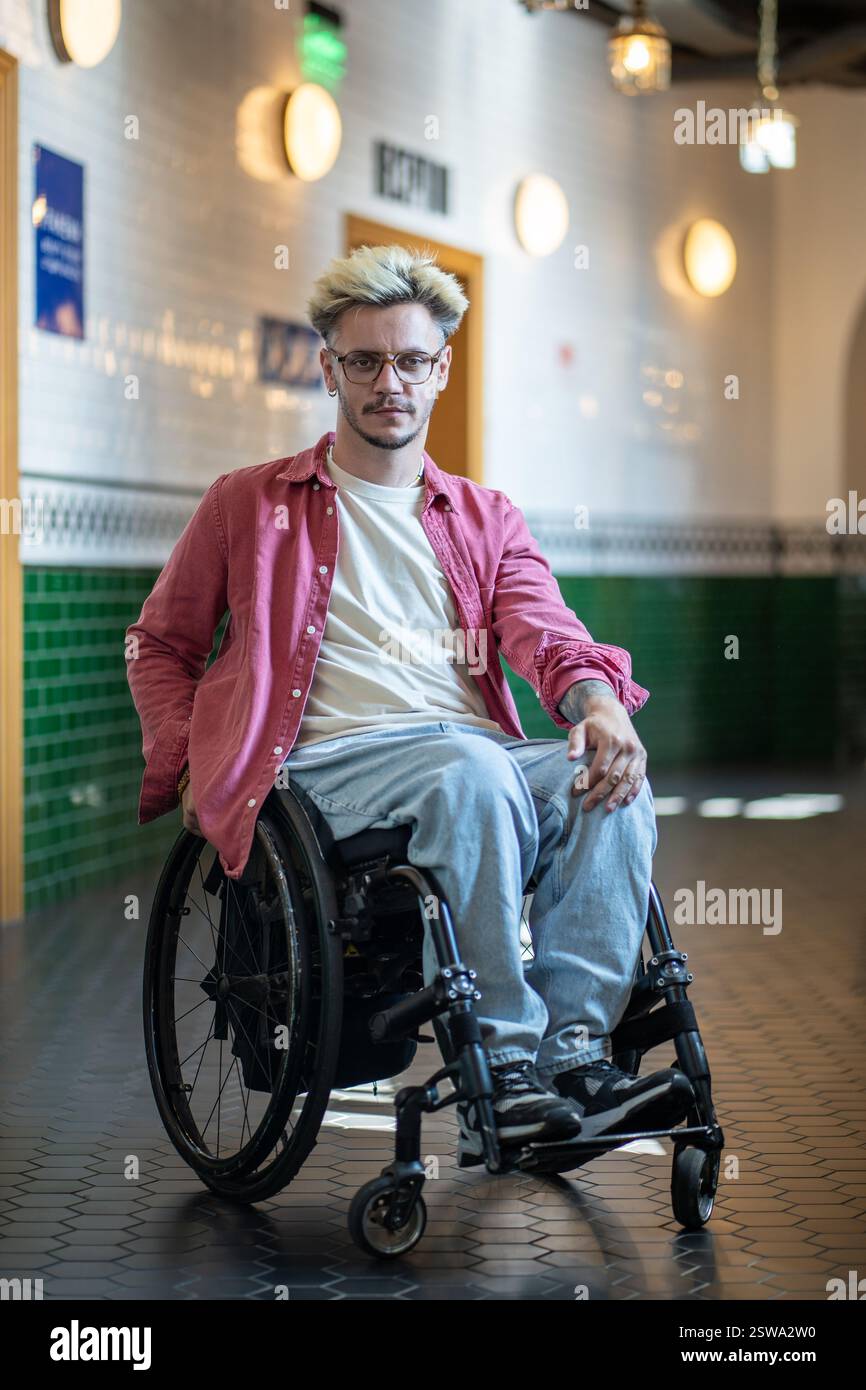 Concerned serious disabled man in wheelchair wait alone in building ...