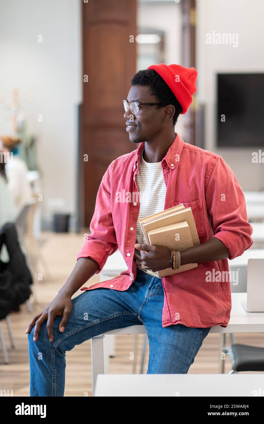 Black student guy looking out of window thinking about weekend plans ...
