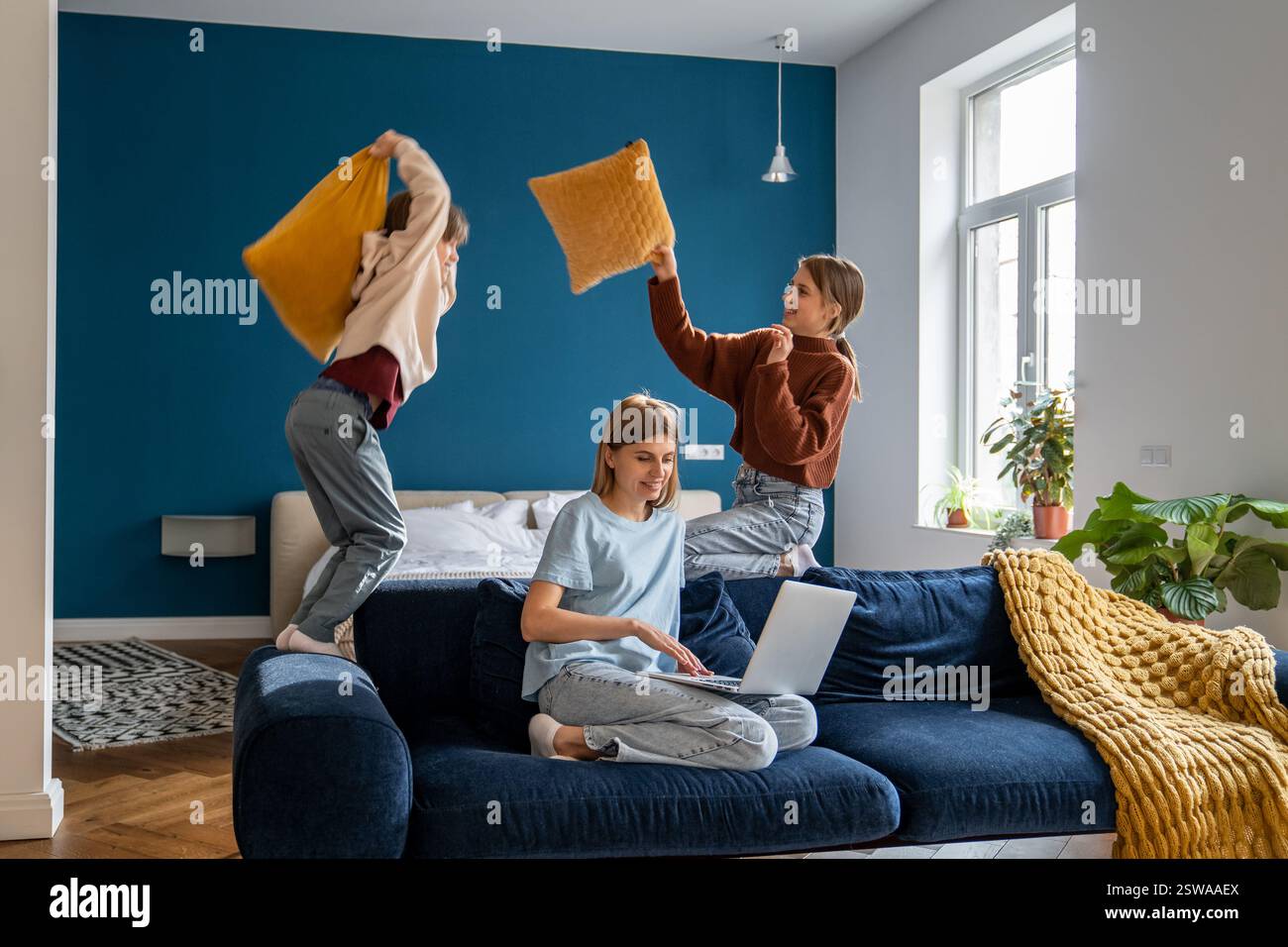 Naughty brother and sister freaking out playing pillow fight near busy ...