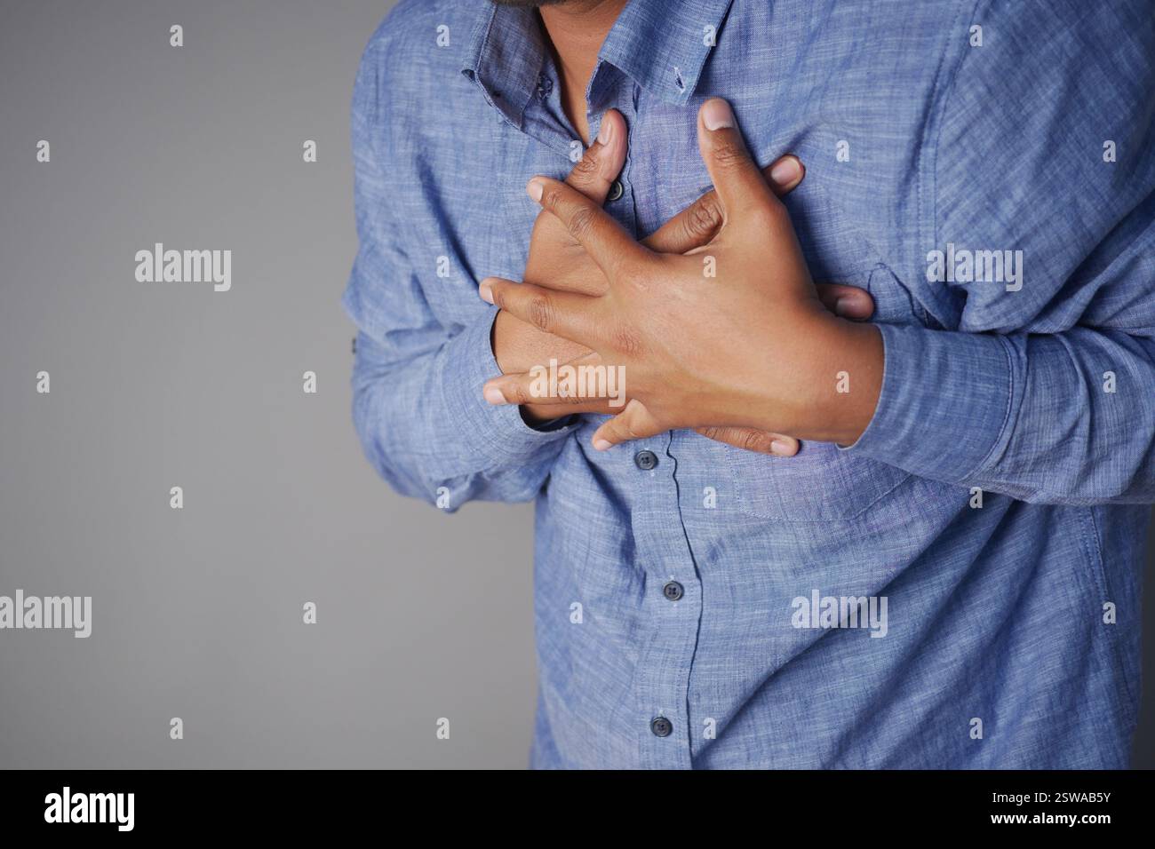 Man chest pain blue shirt hi-res stock photography and images - Alamy
