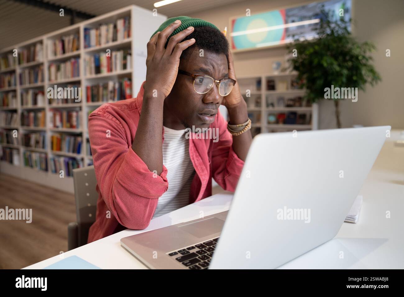 Unhappy black guy freelancer or student look at laptop screen shocked ...