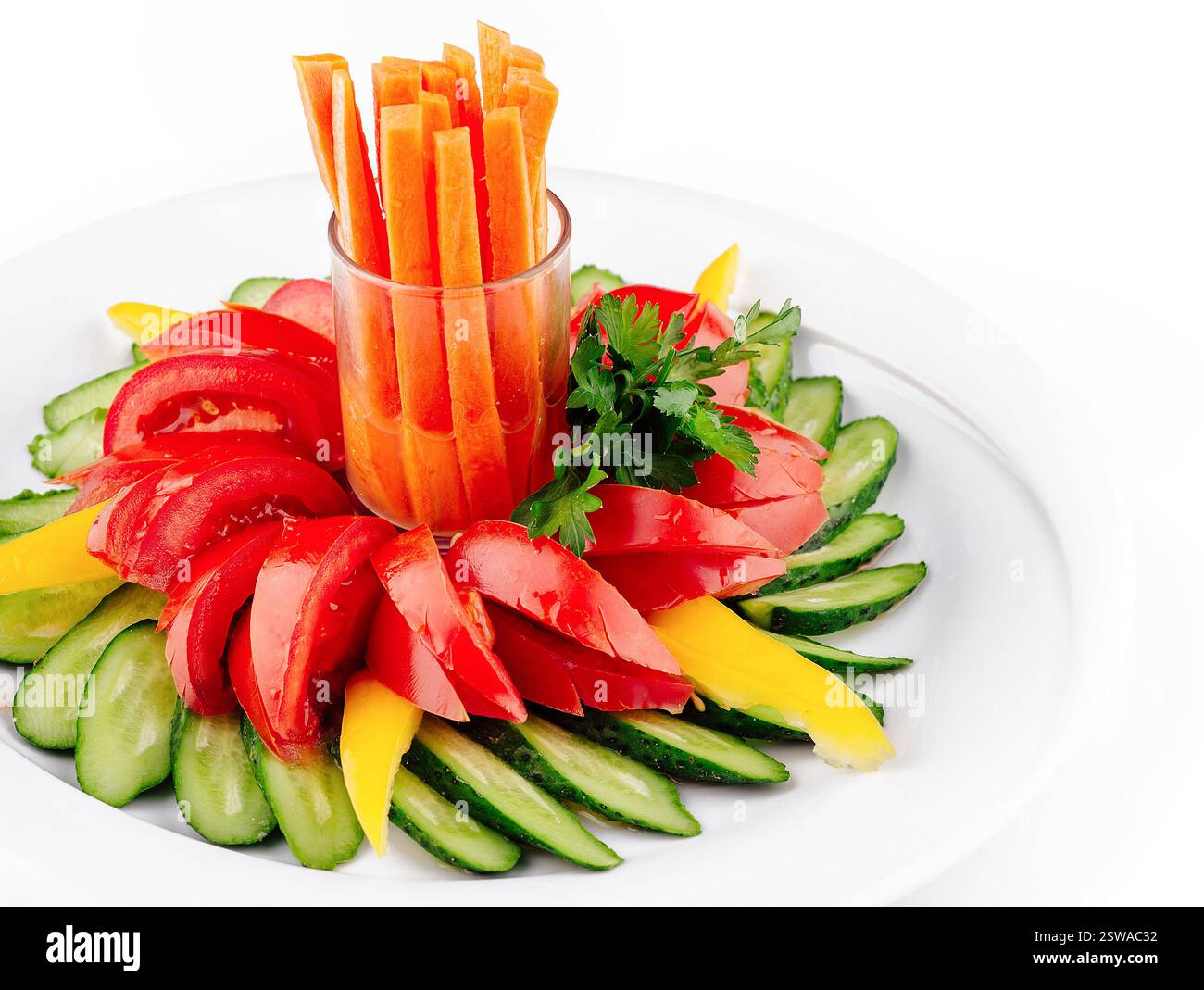 Fresh vegetables arranged on plate forming flower shape with carrots in ...