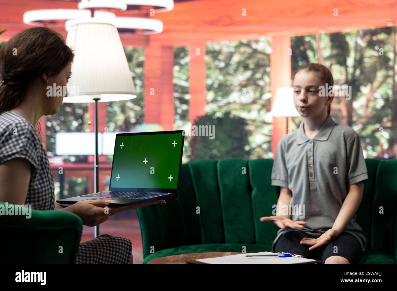 Teen girl in behavioral therapy next to copy space mockup discussing ...