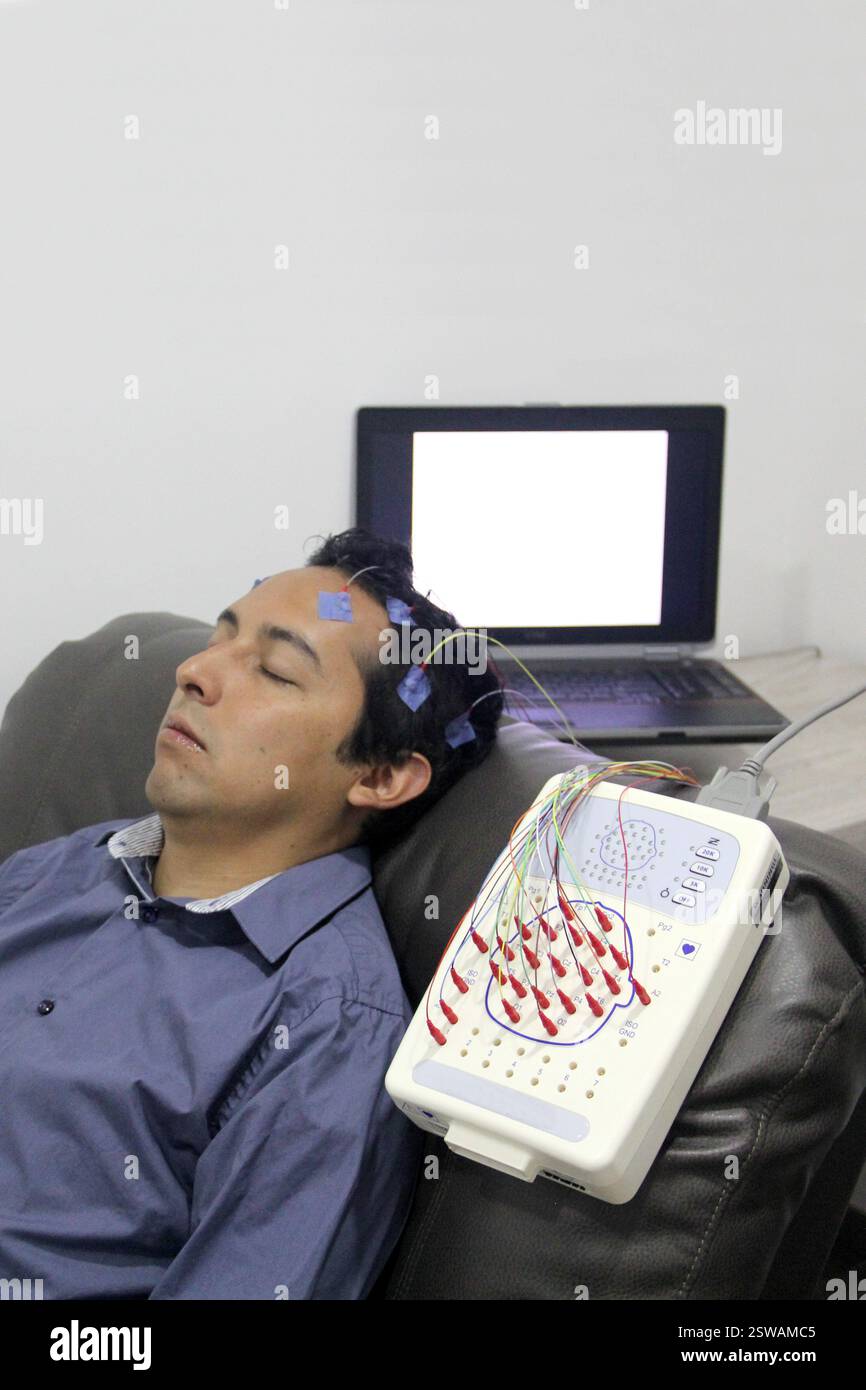 Electroencephalogram EEG in adult Latino man with wires in his head ...