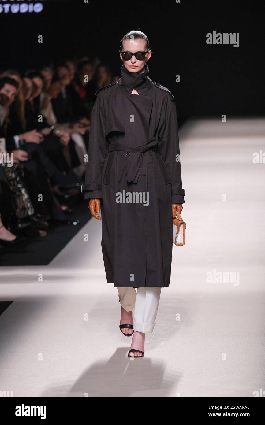 A model walks the runway wearing a design by Alex Riviere during ...