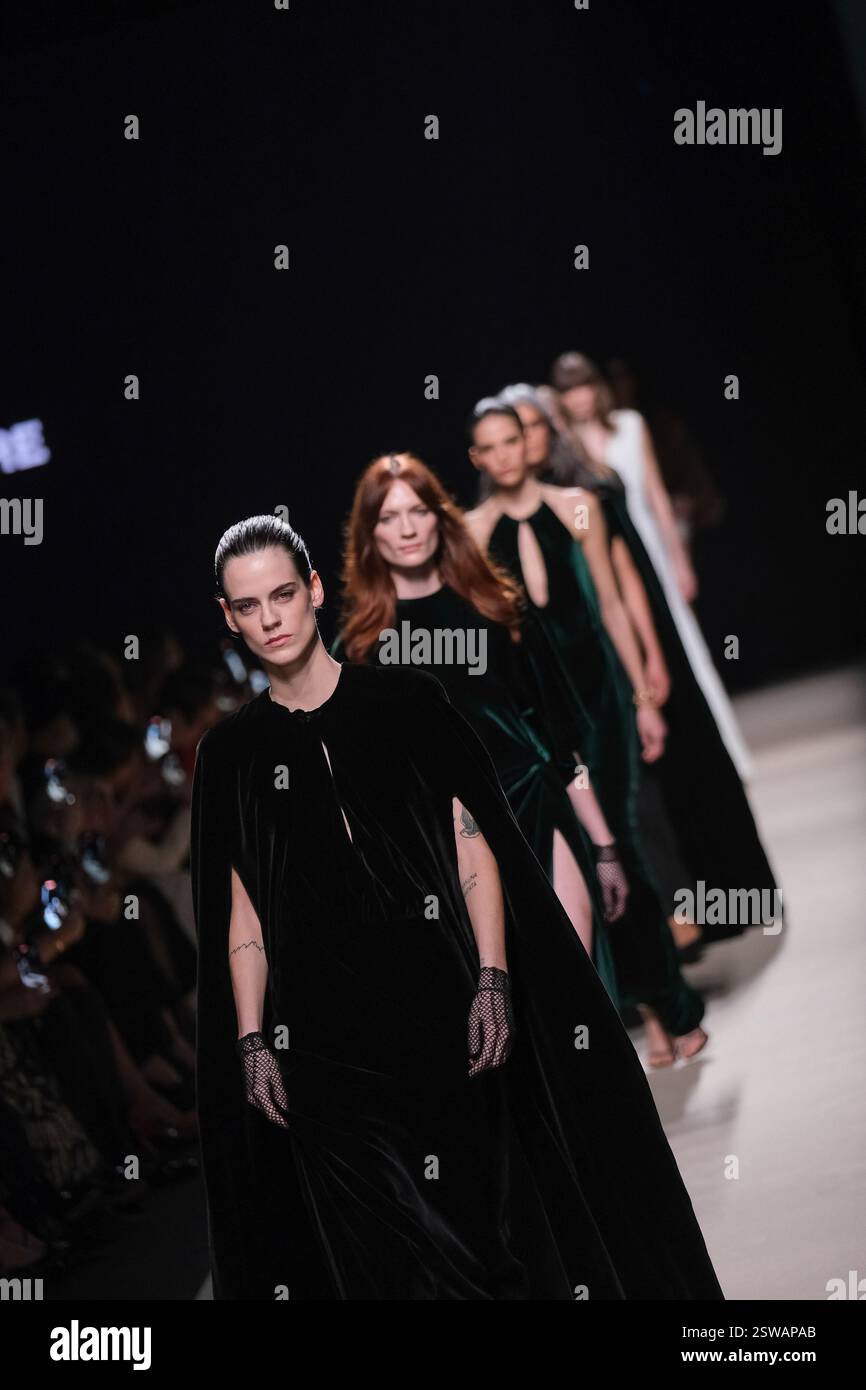 A model walks the runway wearing a design by Alex Riviere during ...