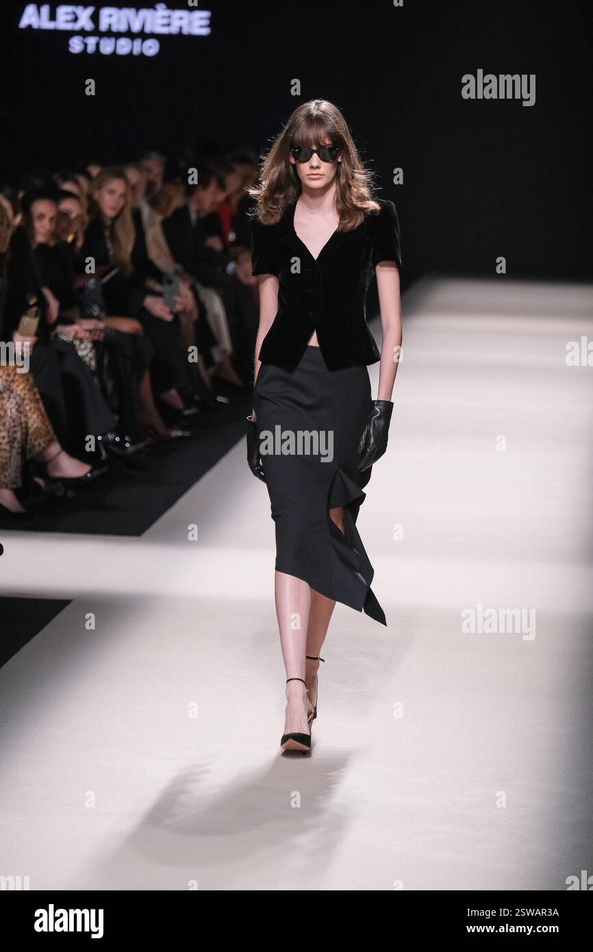 A model walks the runway wearing a design by Alex Riviere during ...