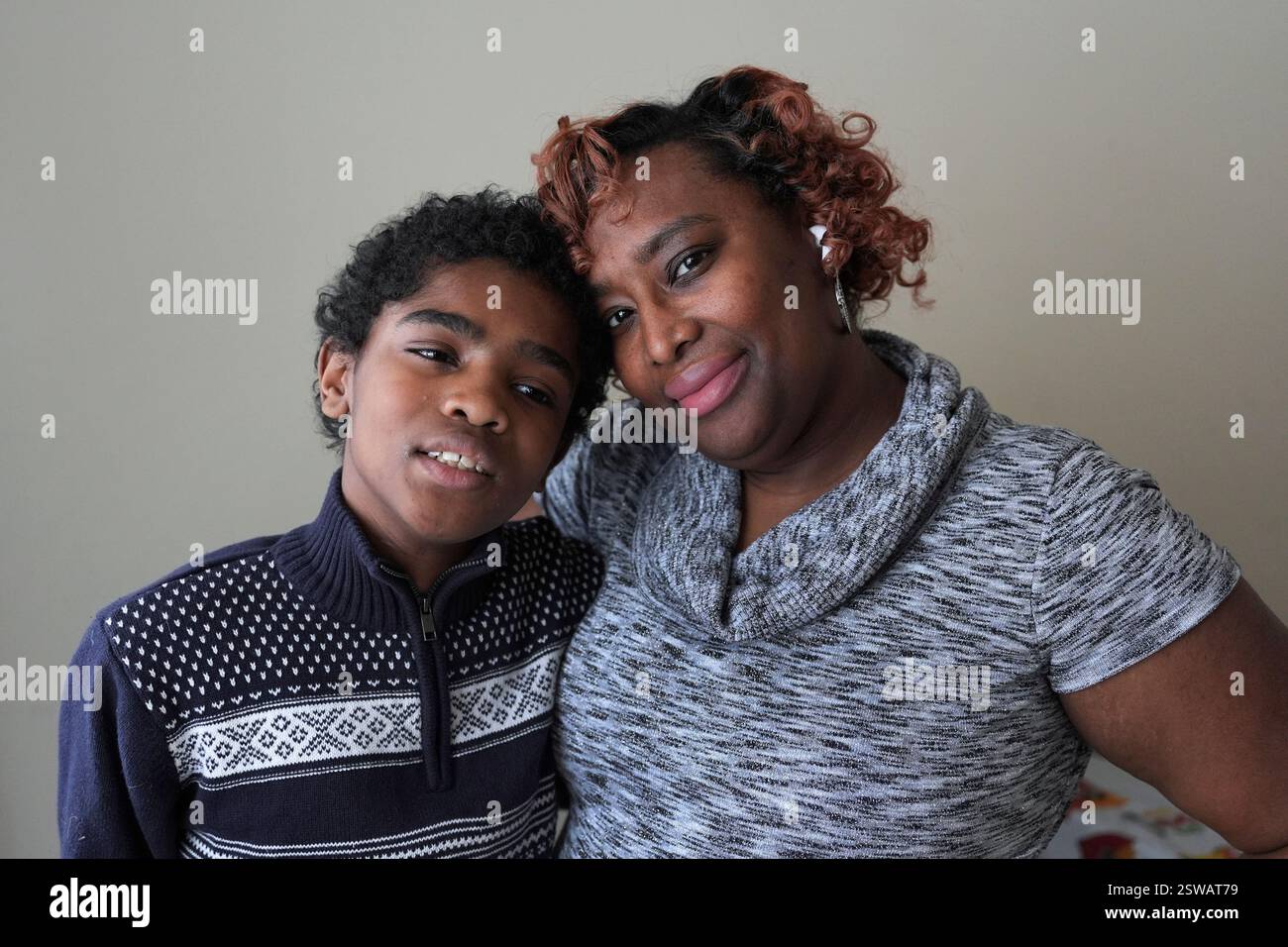 DarNisha Hardaway poses with her son Joseph, 12, at home in Detroit ...