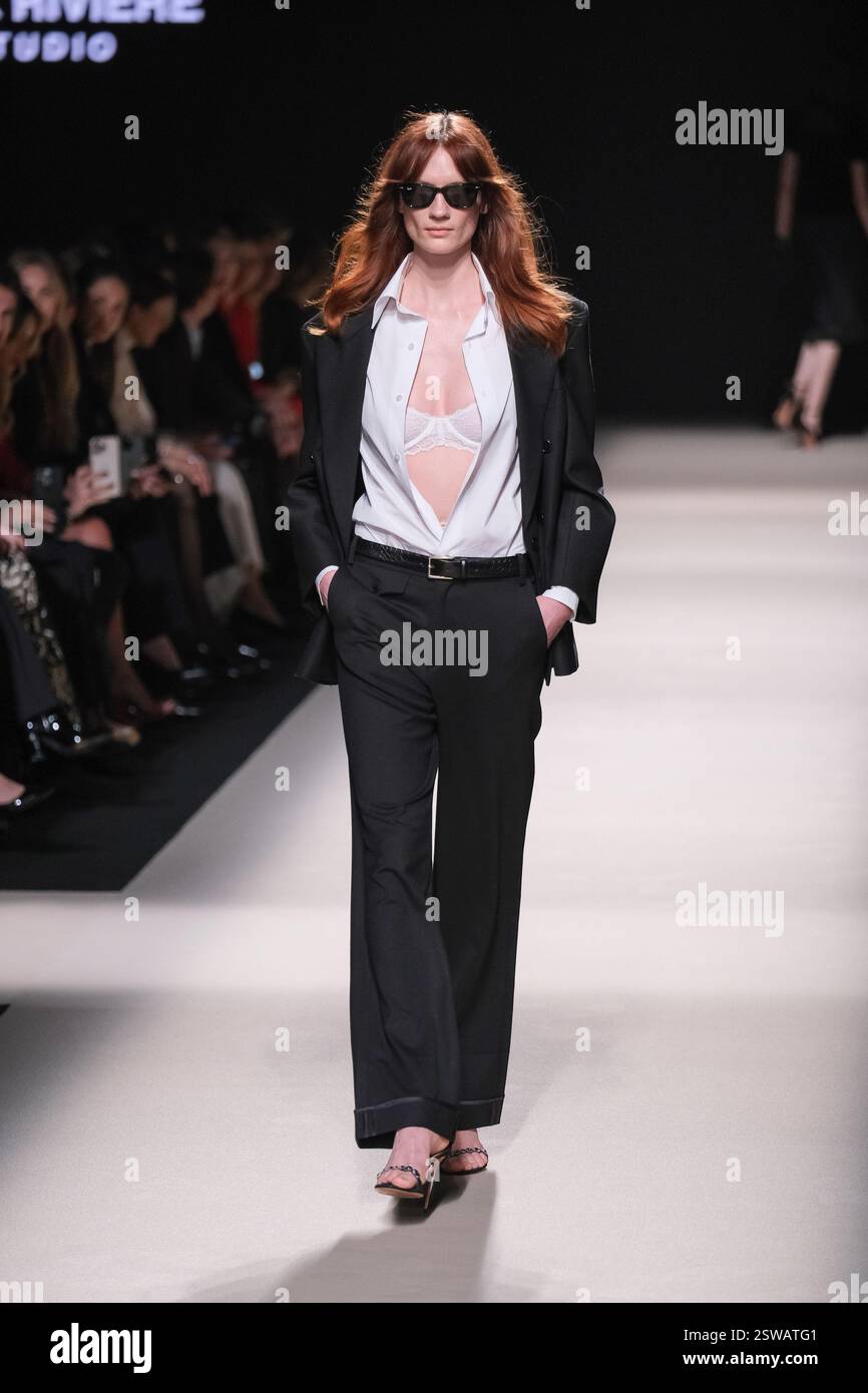 A model walks the runway wearing a design by Alex Riviere during ...