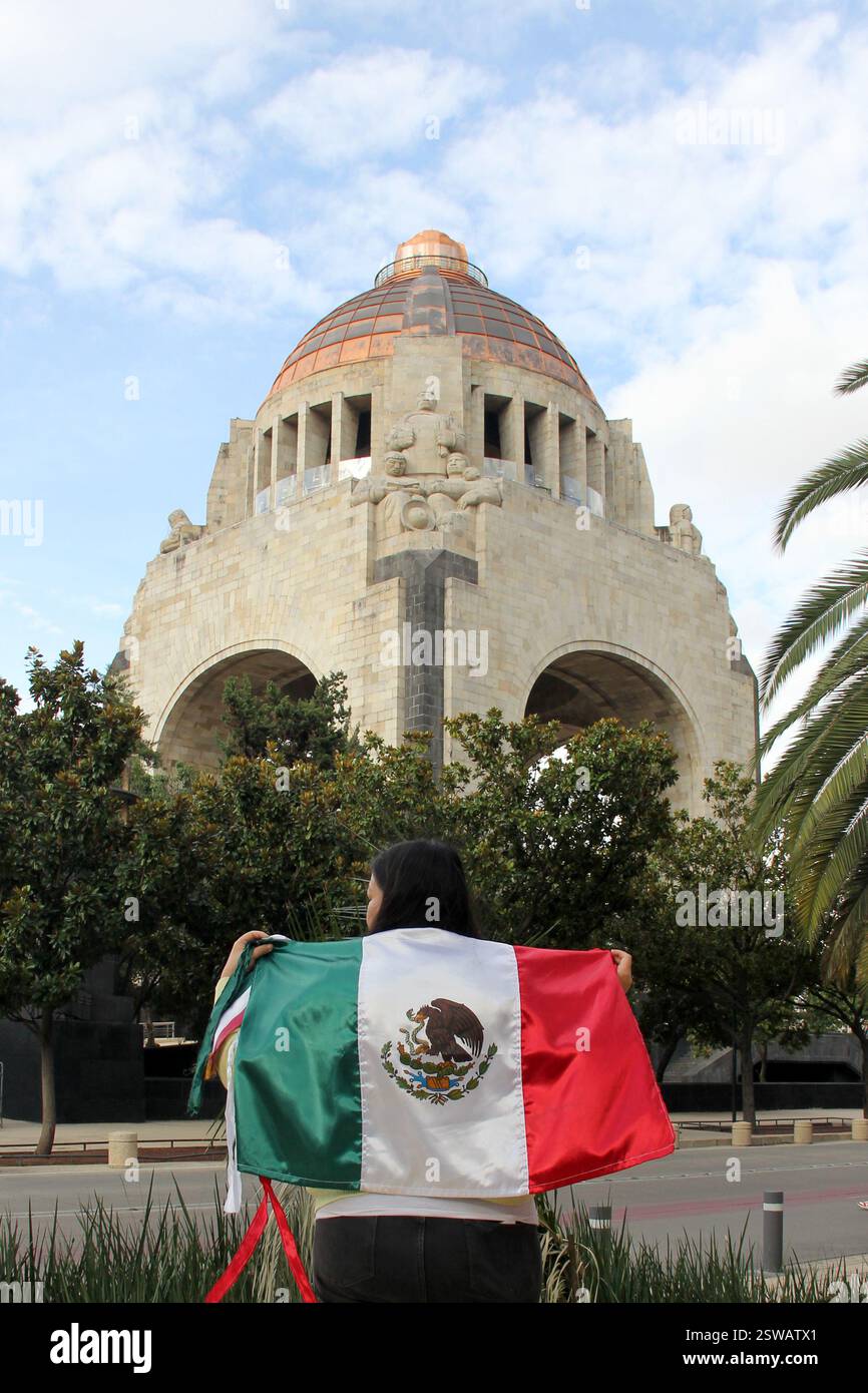 Latina adult woman shows the flag of Mexico with pride to celebrate the ...