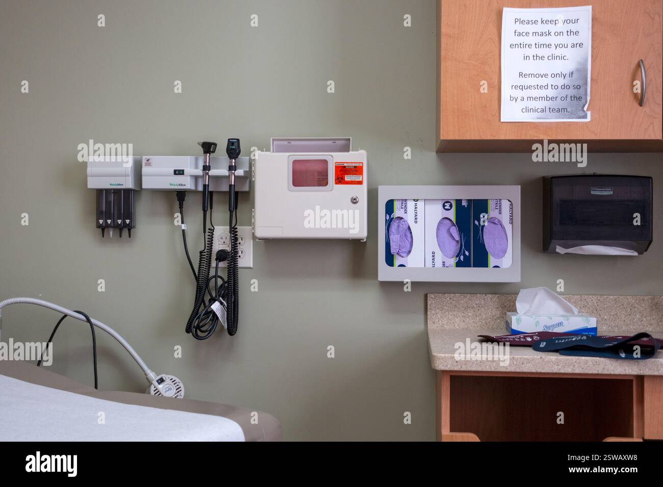 Hospital examination room with sterile gloves, needle dispenser and ...