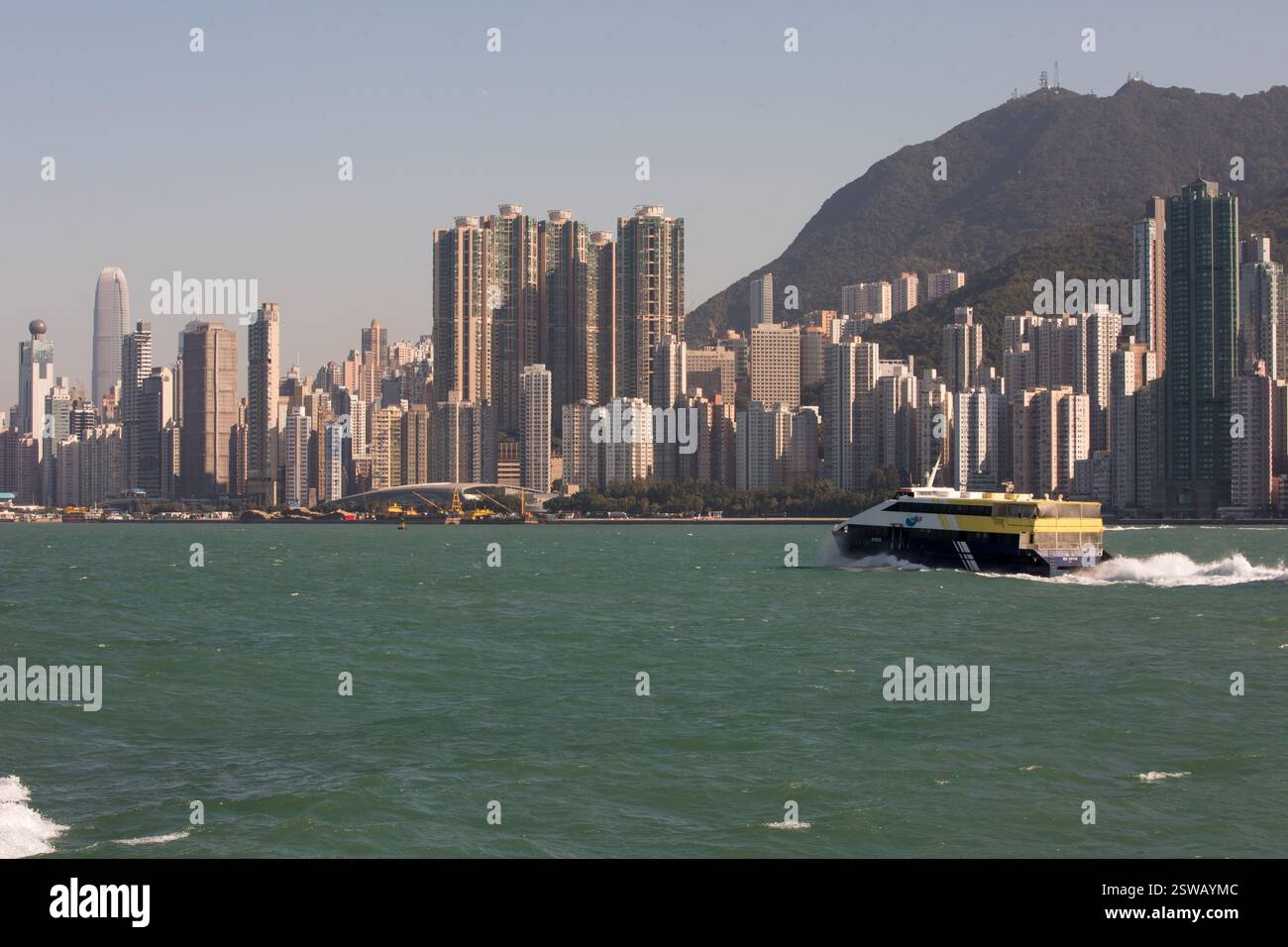 HK ferry (HKF) crosses Victoria Harbour, Hong Kong, past skyscrapers ...