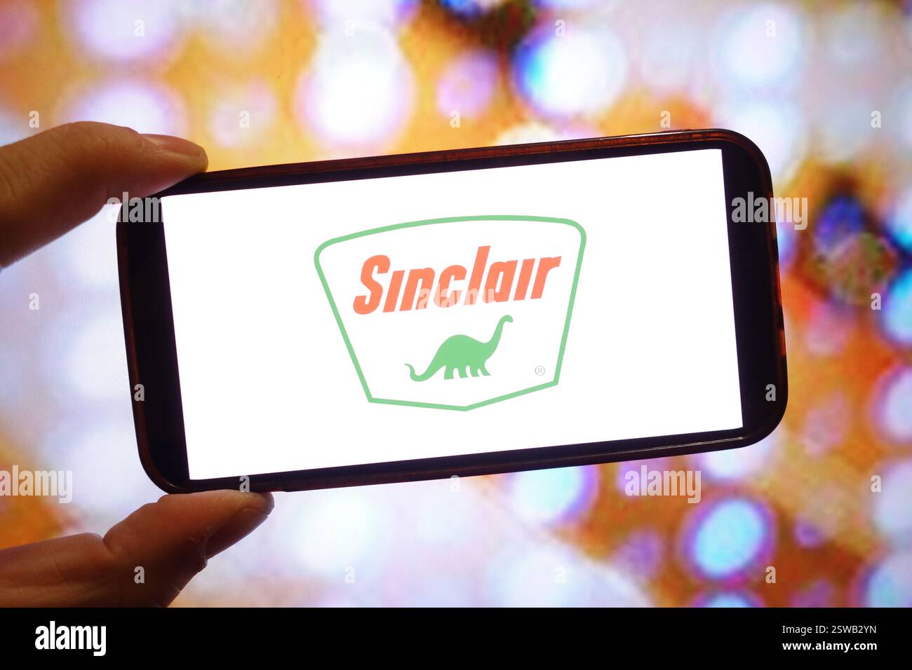 In this photo illustration, the HF Sinclair company logo is seen displayed on a smartphone ...