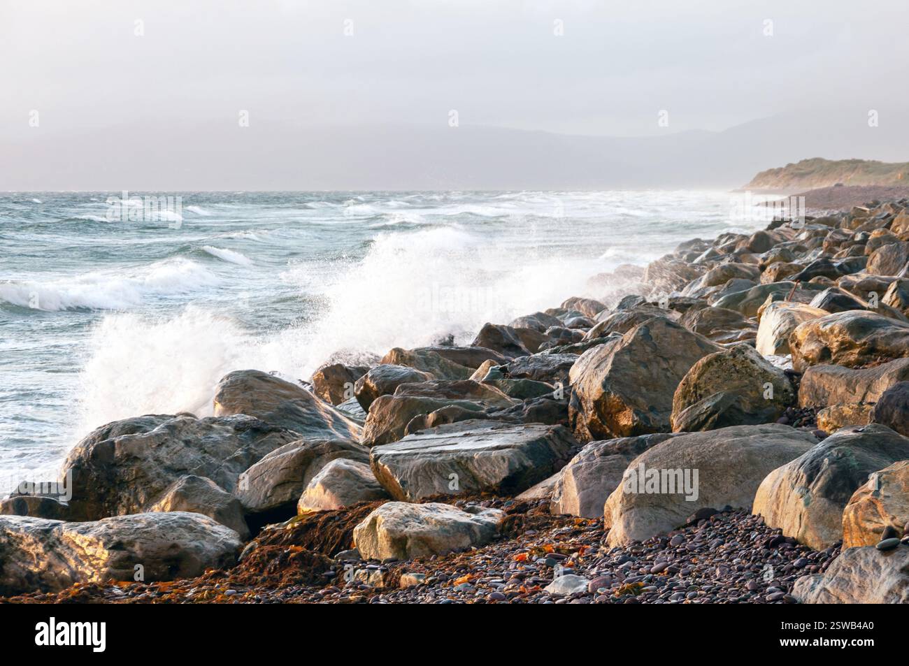 The ocean is rough and the rocks are large. The waves are crashing ...