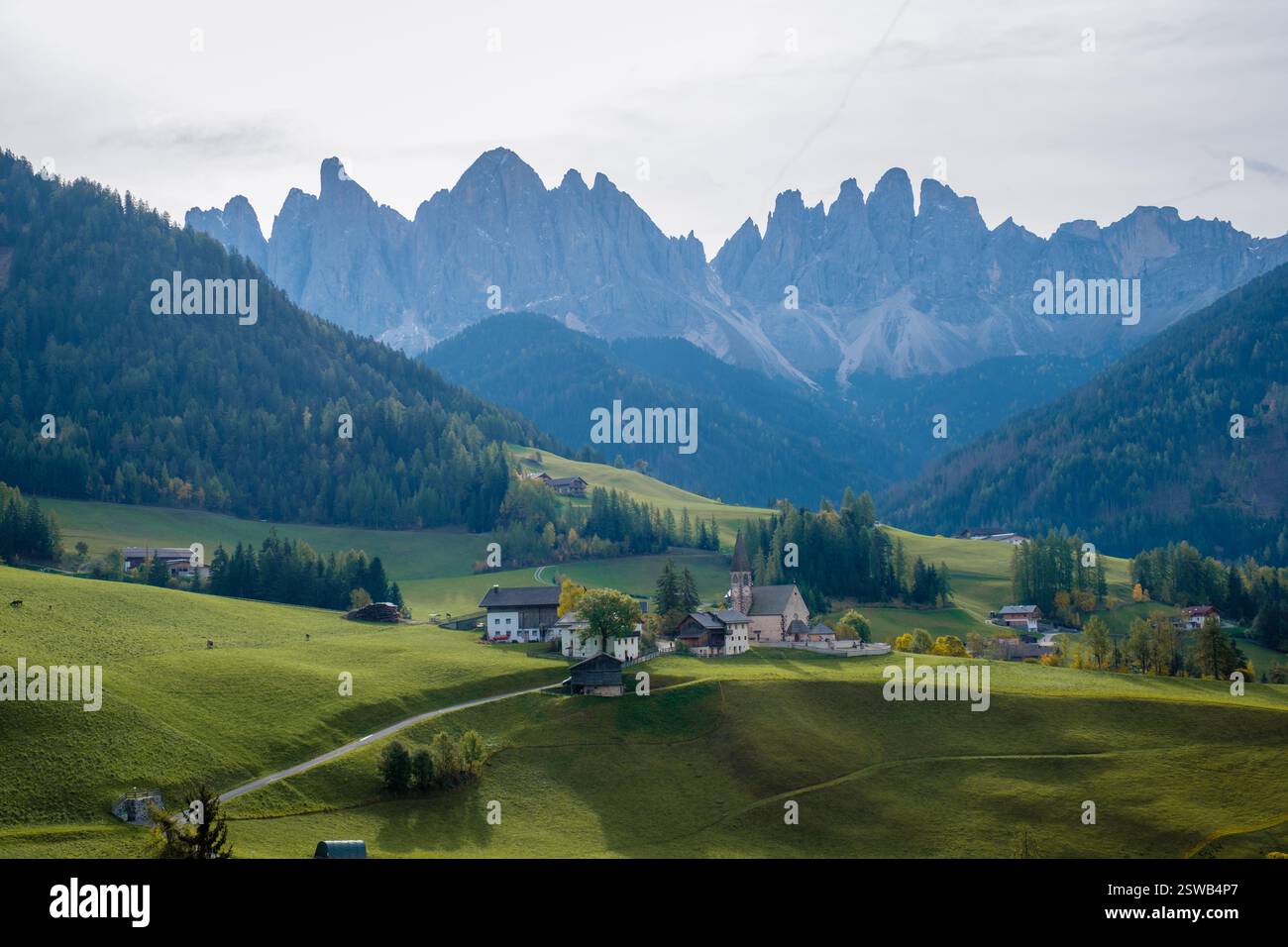 Vibrant autumn foliage contrasts with the rugged peaks of the Dolomites ...