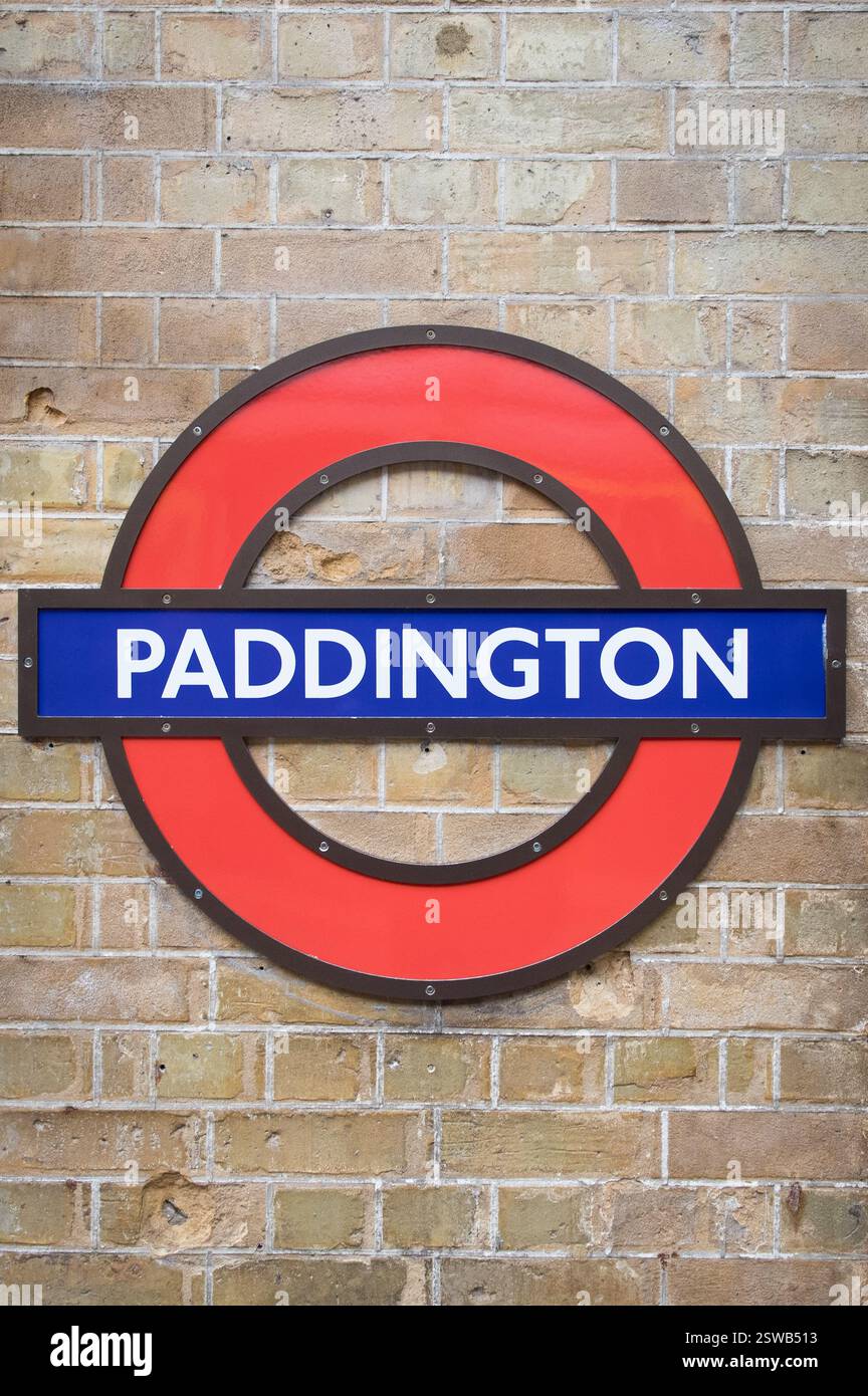 London Underground Paddington station sign, on a brick wall. The iconic ...