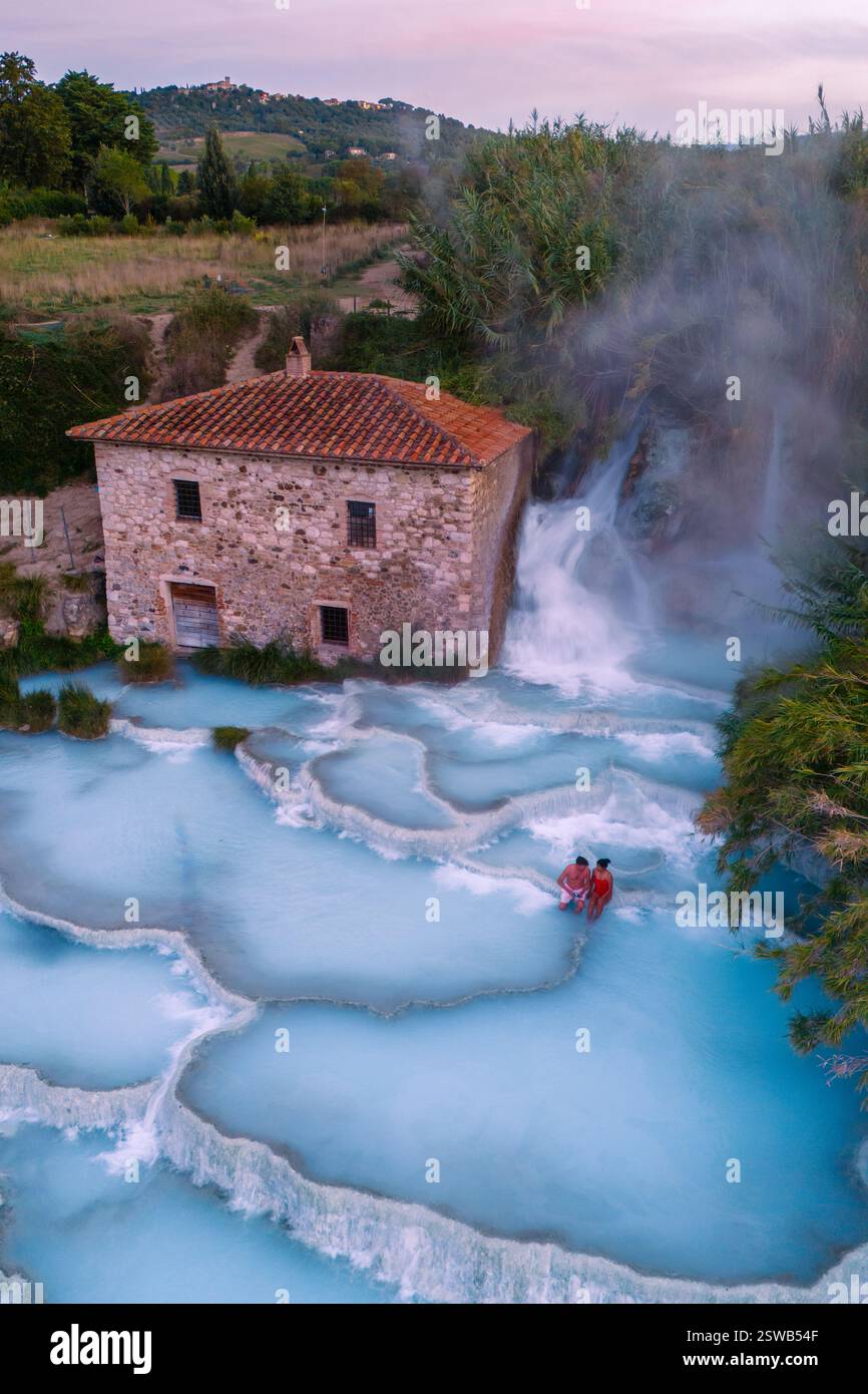 Relaxing in the natural thermal pools of Saturnia, Tuscany at sunset ...