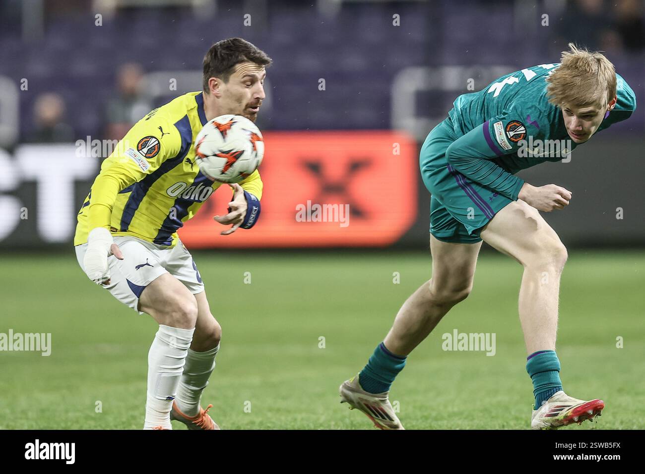 Fenerbahce's Mert Hakan Yandas and ANderlecht's Nathan De Cat fight for ...