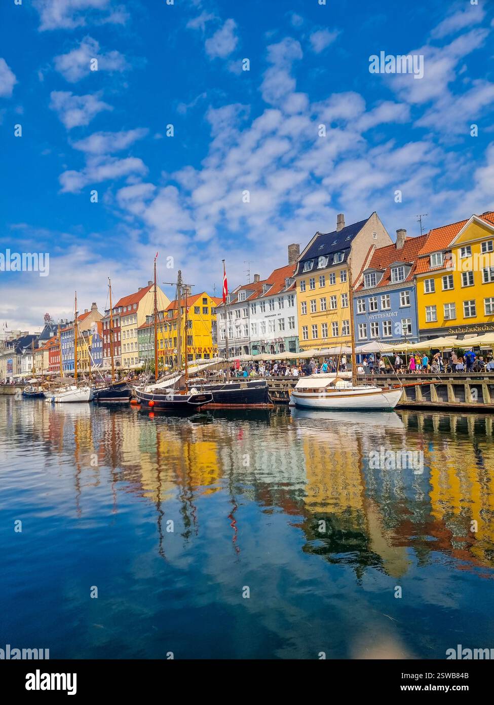 Charming waterfront lined with colorful buildings and sailboats in ...