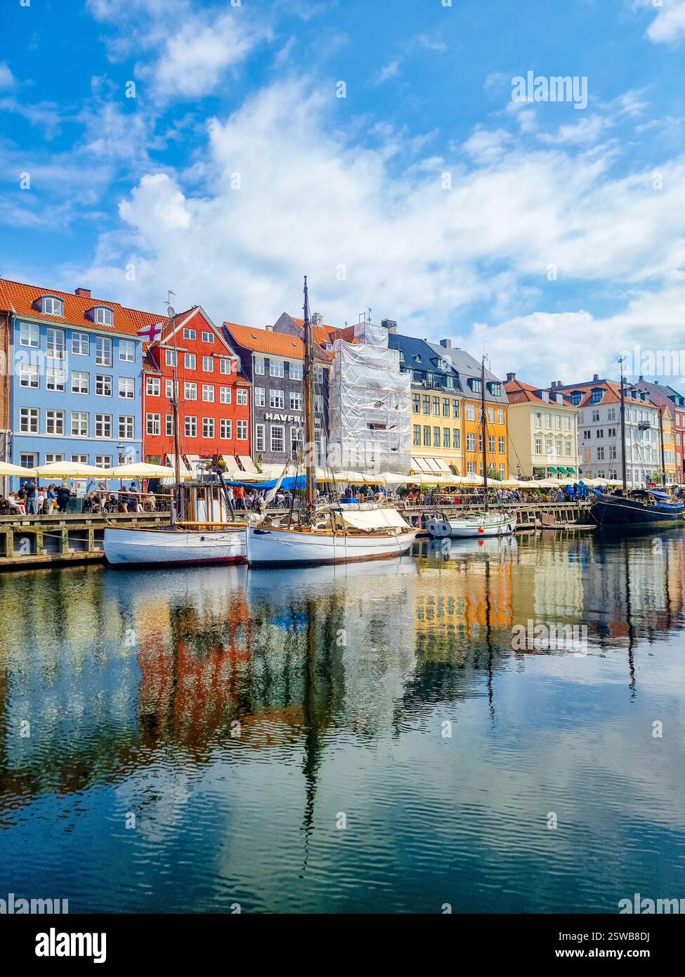 Colorful waterfront buildings reflect beautifully in the calm waters of ...