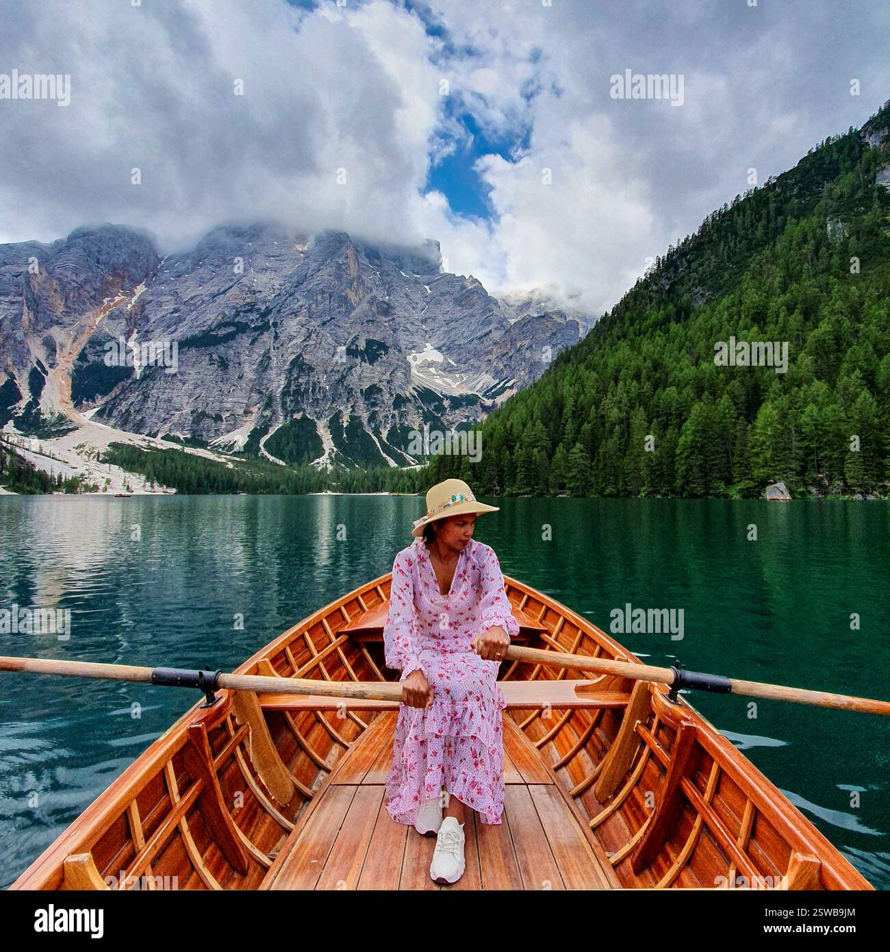 A serene boat ride on a tranquil lake amidst majestic mountains Lago Di ...