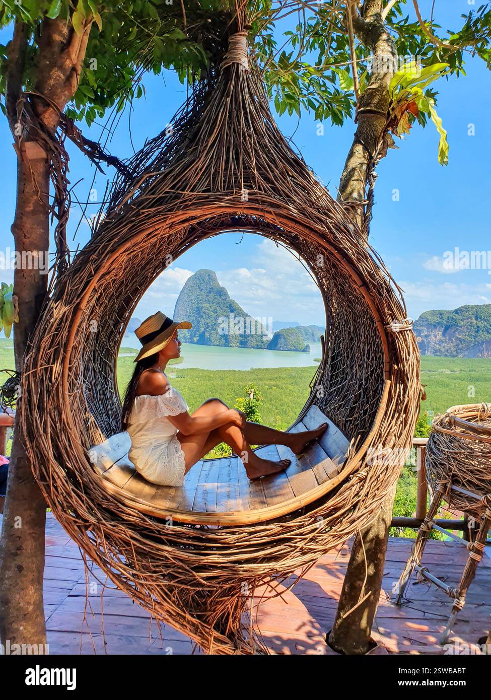 Embraced by nature, a woman sits peacefully in a beautifully crafted ...