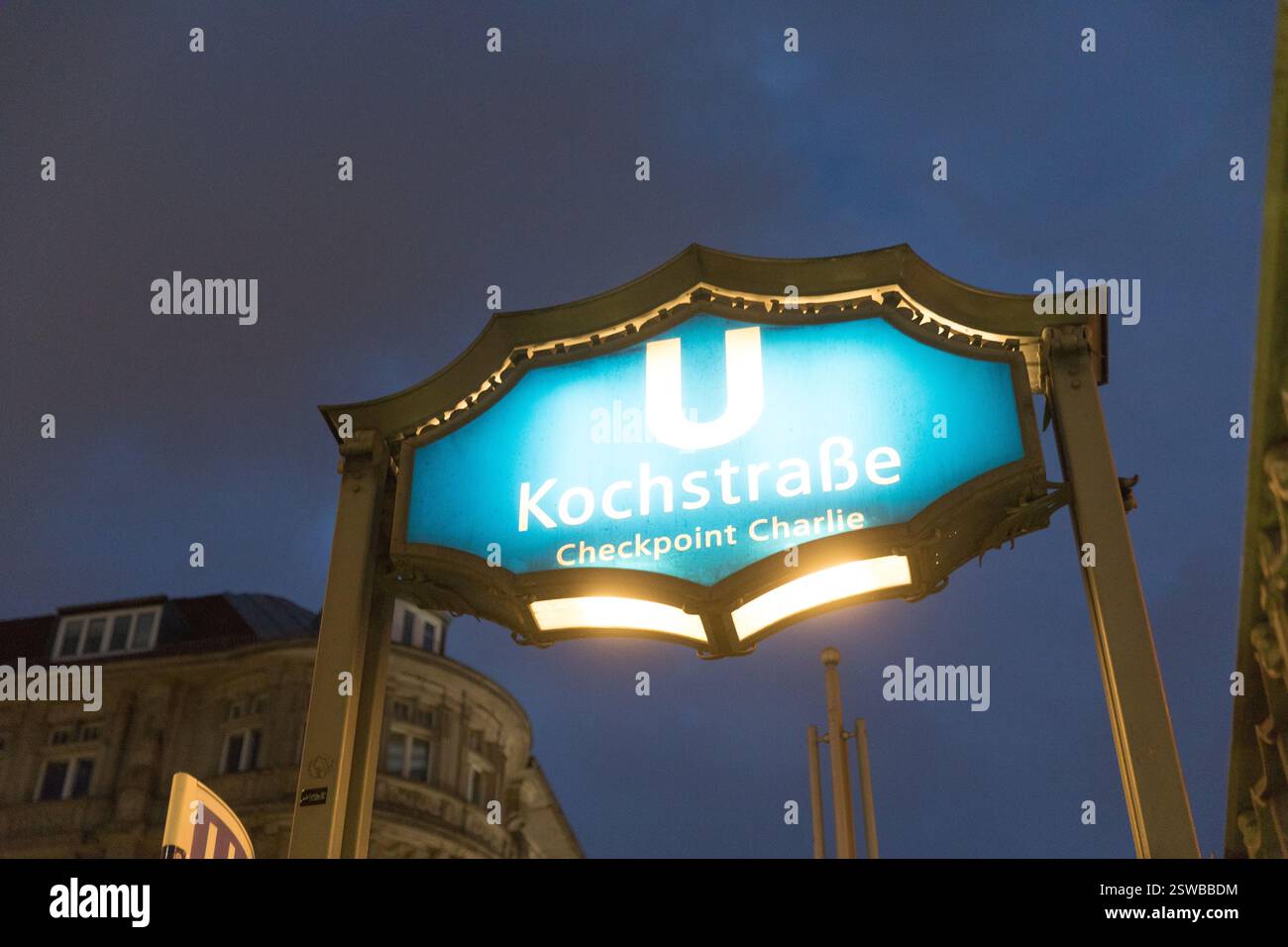 Berlin's Checkpoint Charlie U-Bahn station sign at night. The sign ...