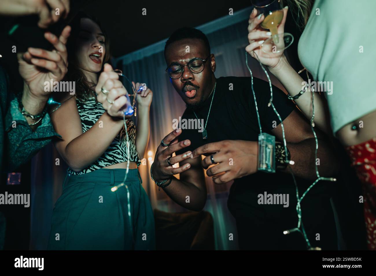 A lively scene featuring friends enjoying a celebration with music ...