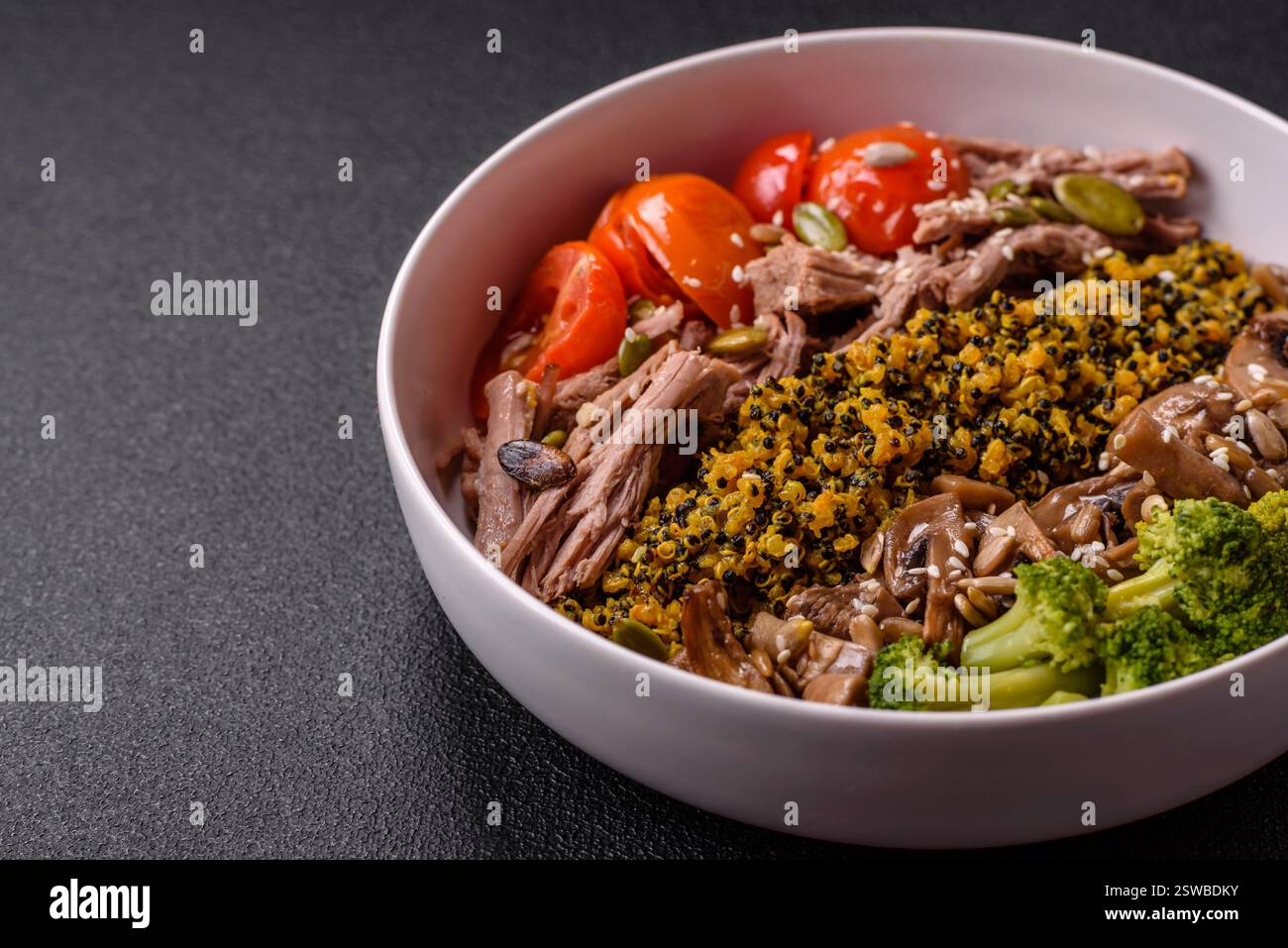 Quinoa bowl with tofu, steamed vegetables, grains, seeds and spices ...