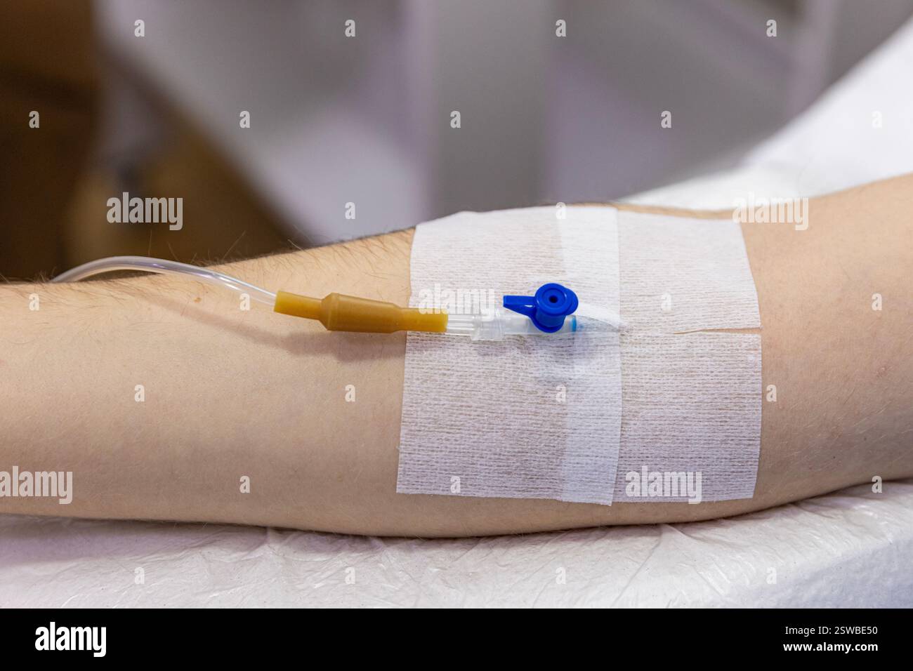 The doctor inserts a needle into the vein of the patient. Nurse ...