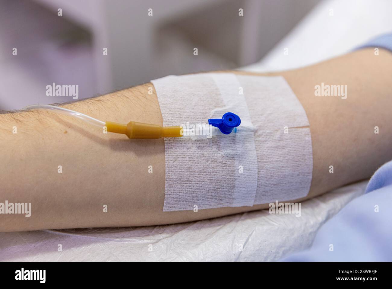 The doctor inserts a needle into the vein of the patient. Nurse connecting an IV drip. Nurse ...