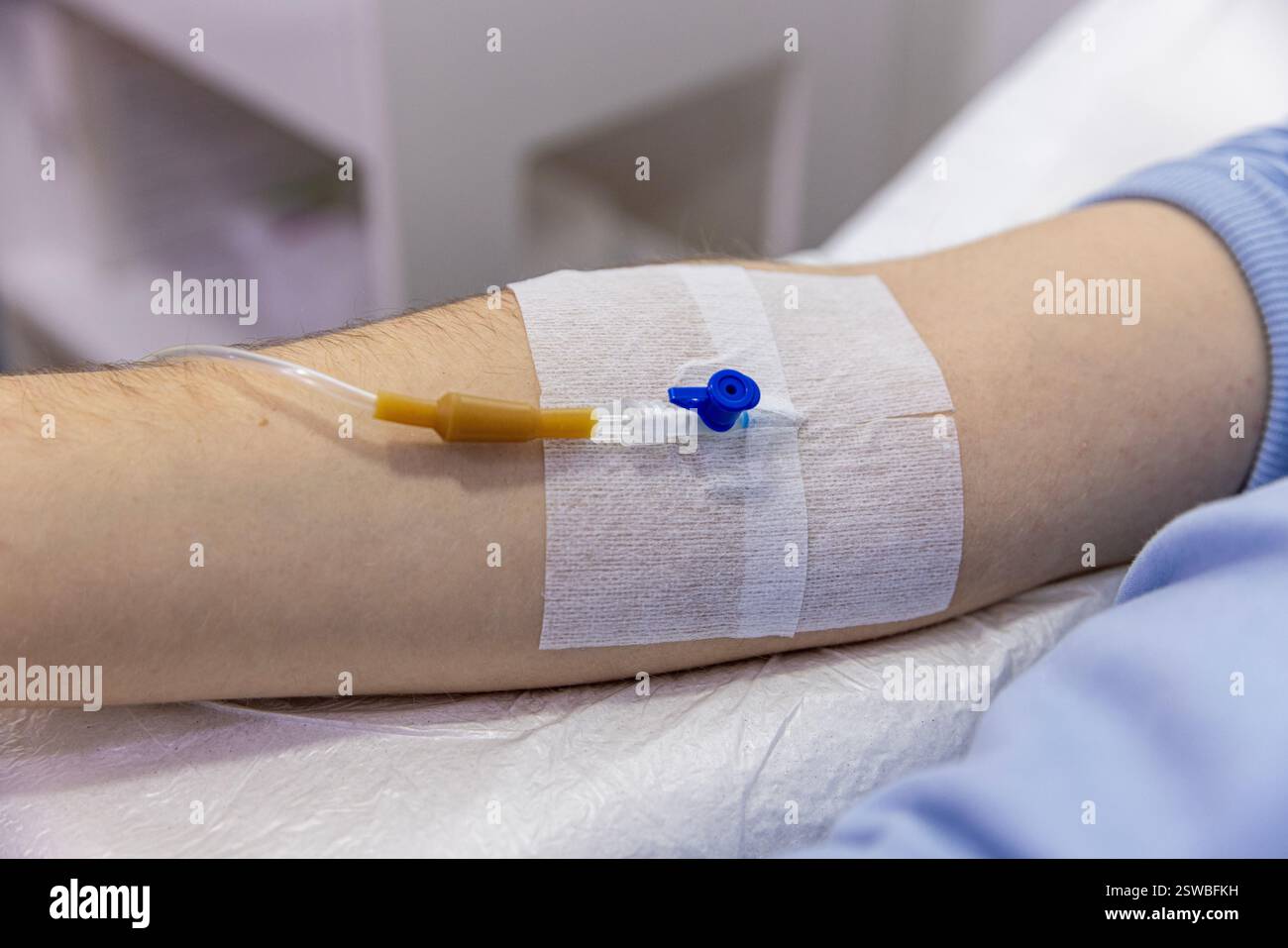 The doctor inserts a needle into the vein of the patient. Nurse ...