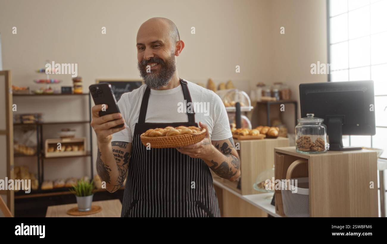 Handsome hispanic man with beard holding pastries and using smartphone ...