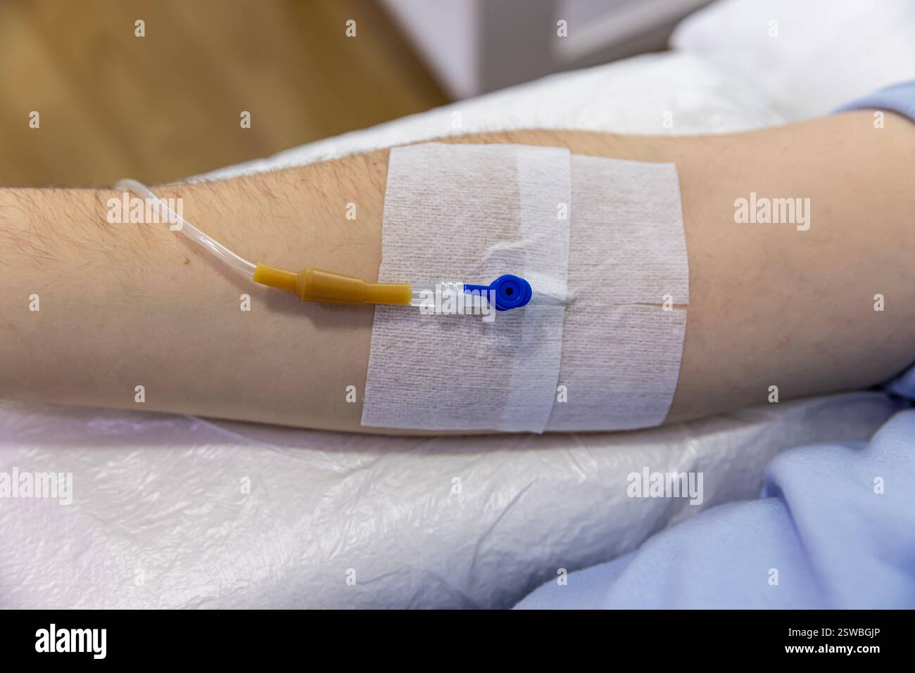 The doctor inserts a needle into the vein of the patient. Nurse connecting an IV drip. Nurse ...