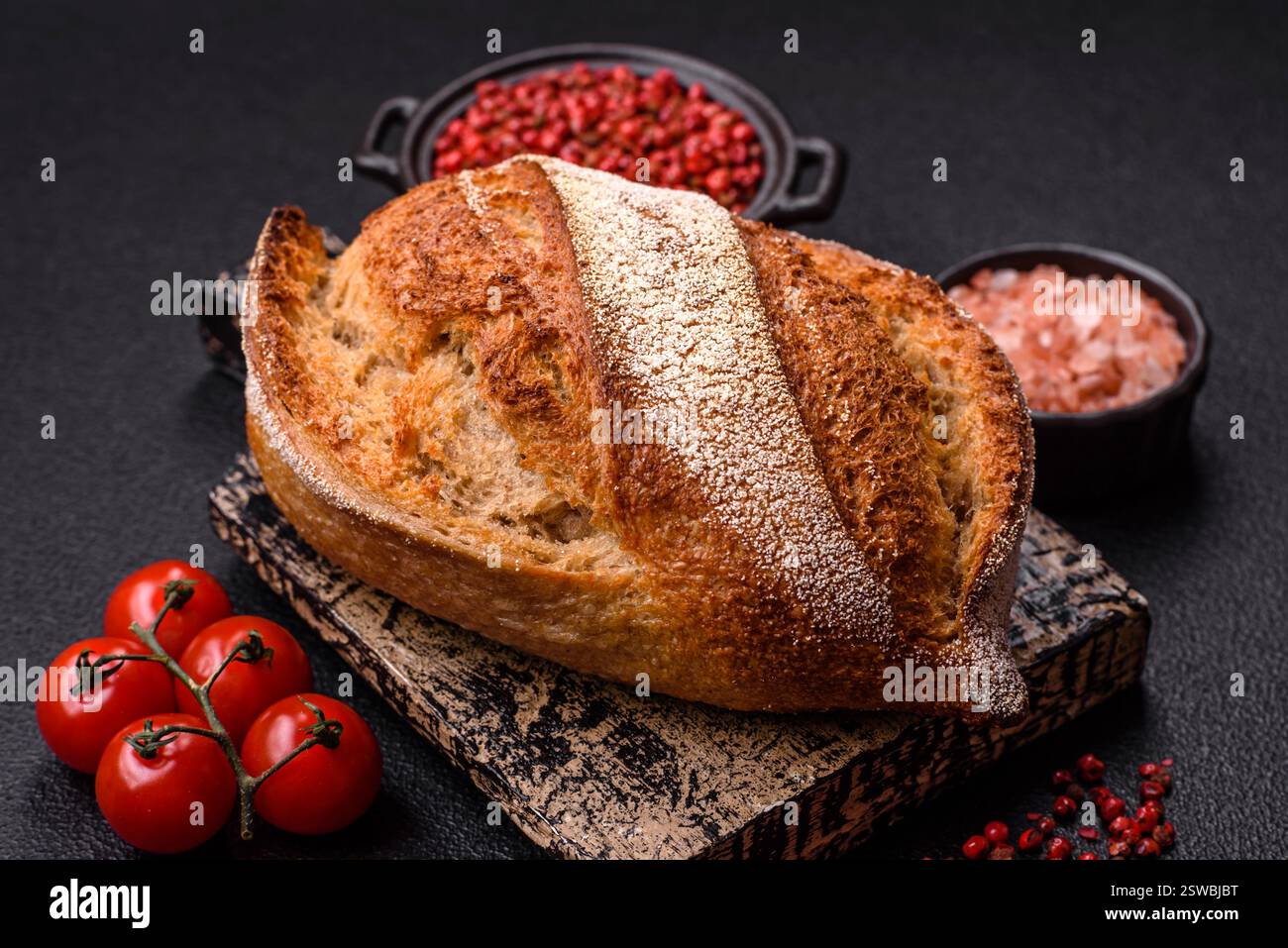 Homemade fresh crispy wholemeal bread on dark concrete background Stock ...