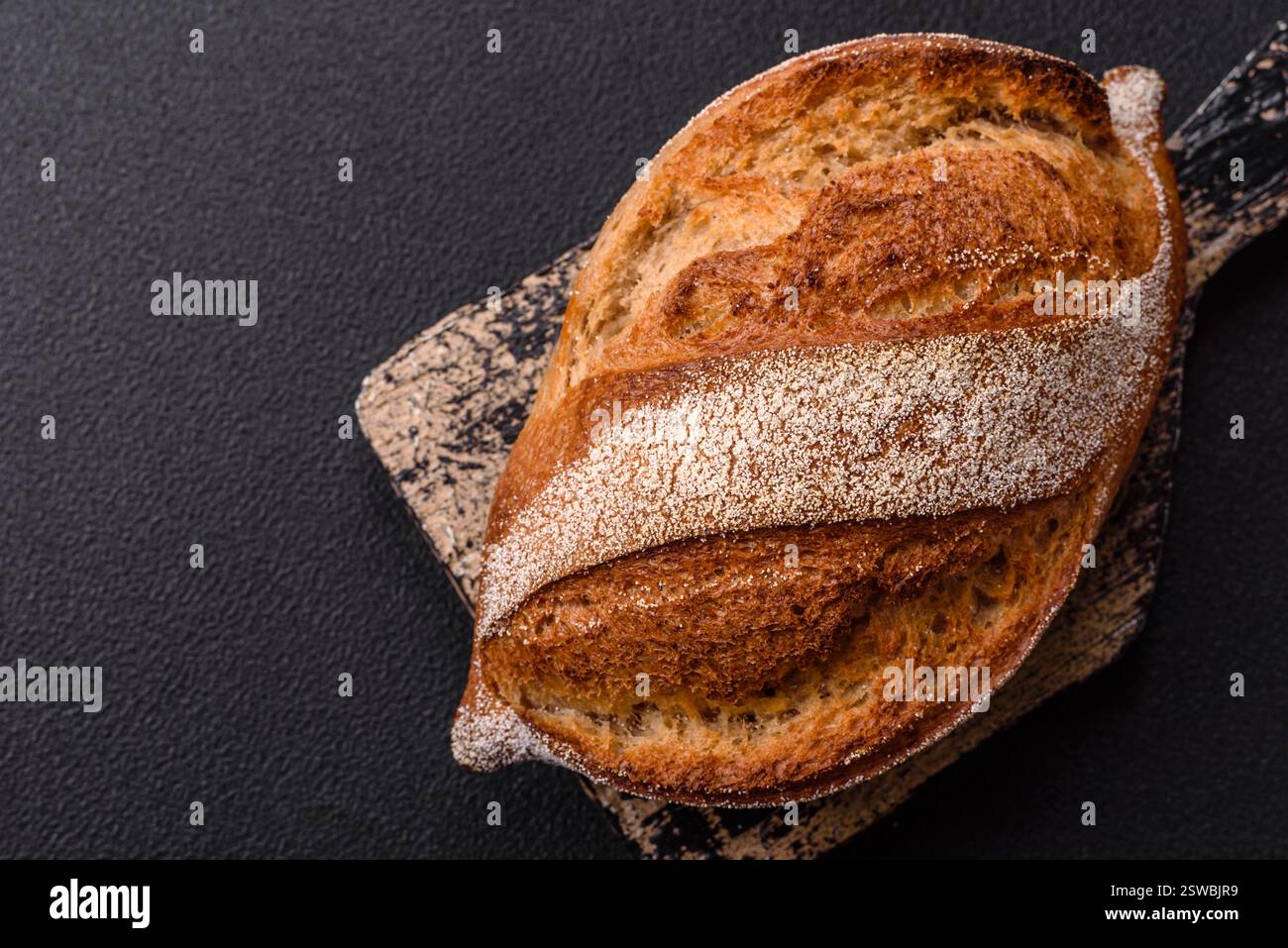 Homemade fresh crispy wholemeal bread on dark concrete background Stock ...