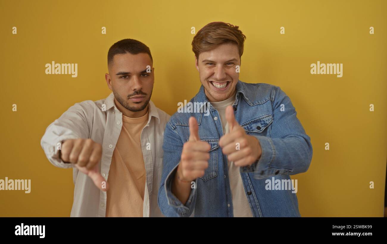 Two men, one with a thumbs up and the other with a thumbs down, stand ...