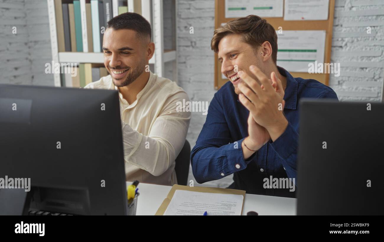 Men working together on a project in an office, demonstrating teamwork ...