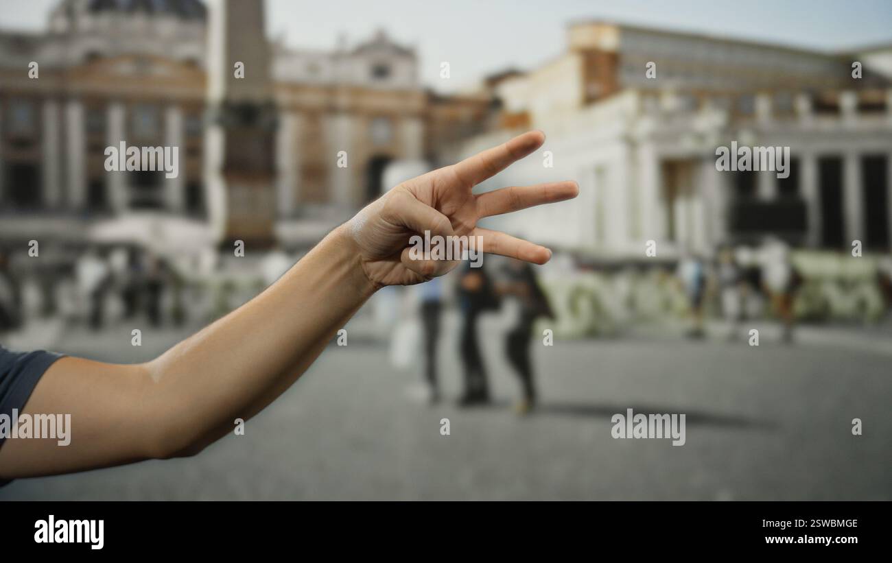 Hand gestures with three fingers extended against the backdrop of st ...