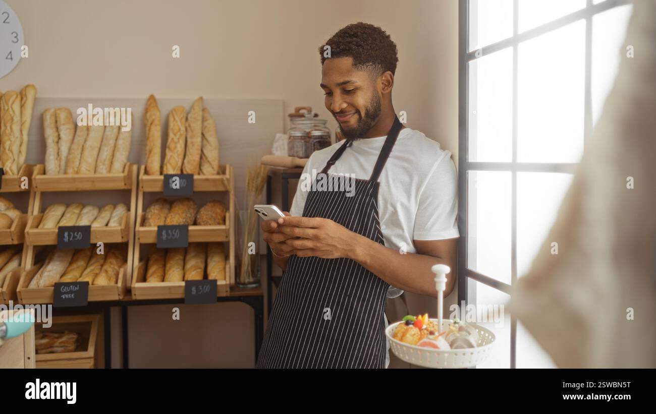 Young man in bakery checking hi-res stock photography and images - Alamy